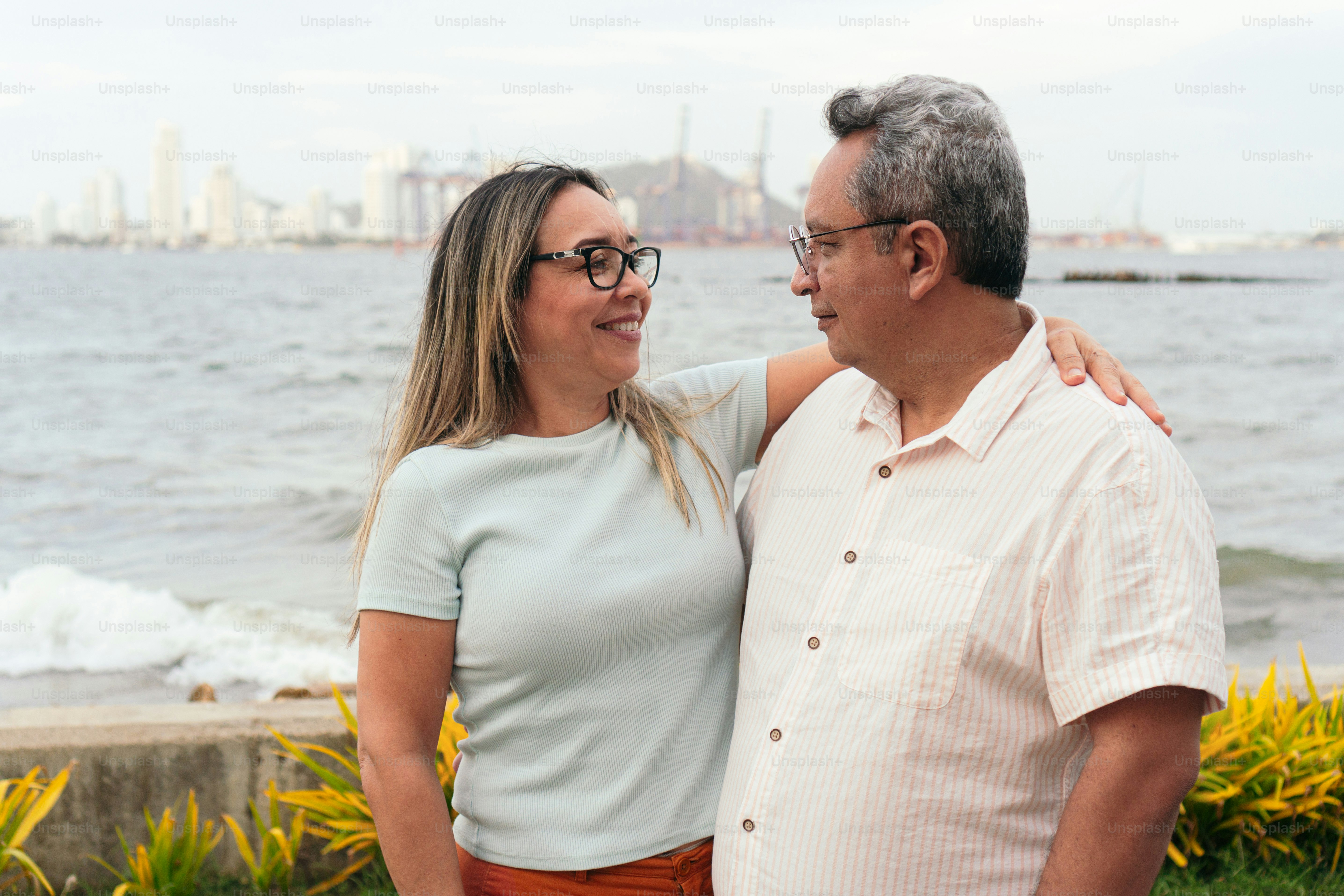 Latin couple in their 50s standing in a park photo – Beach Image on ...