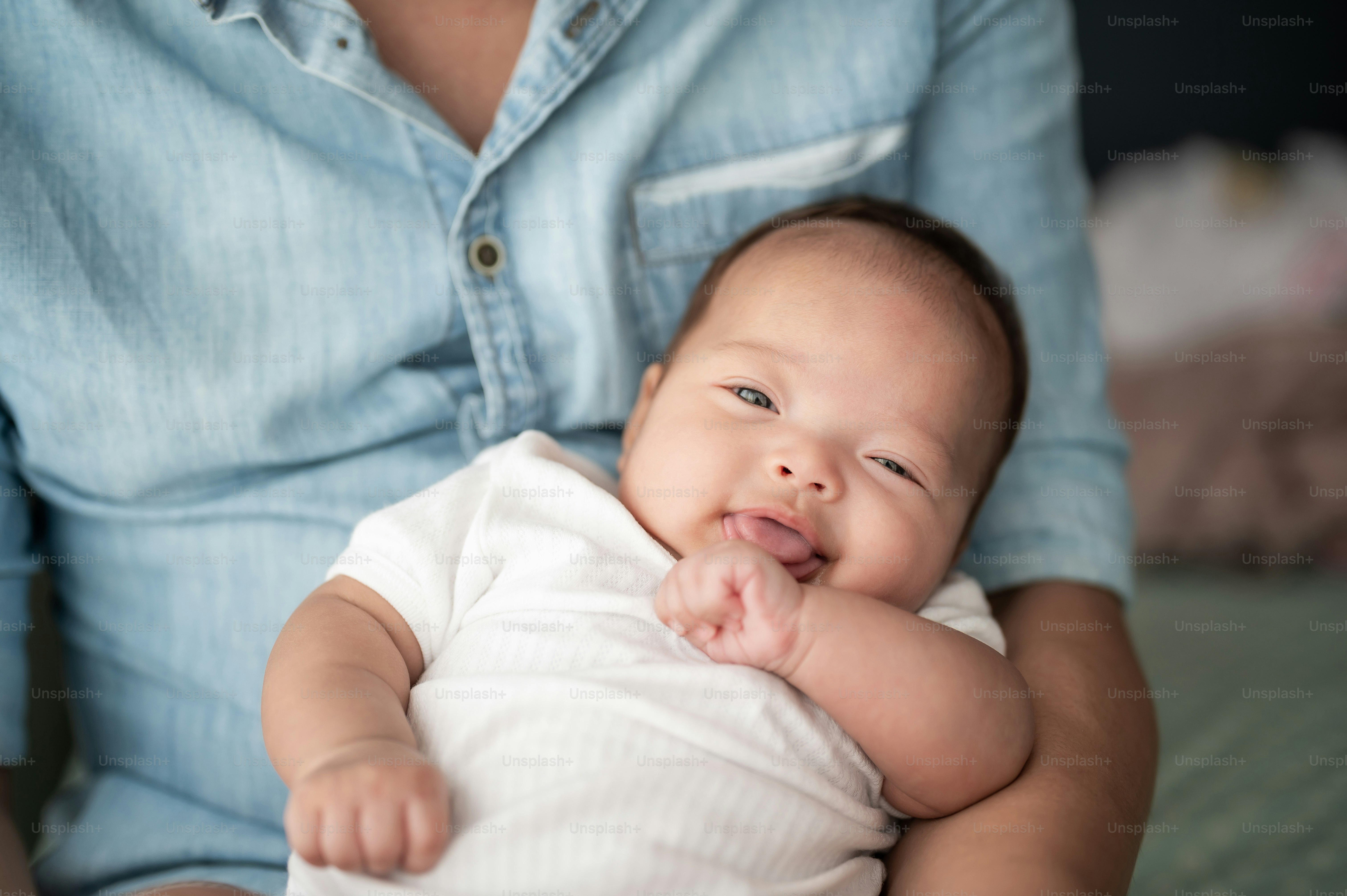 Happy smailing adorable cute daughter baby girl sitting on father lap ...