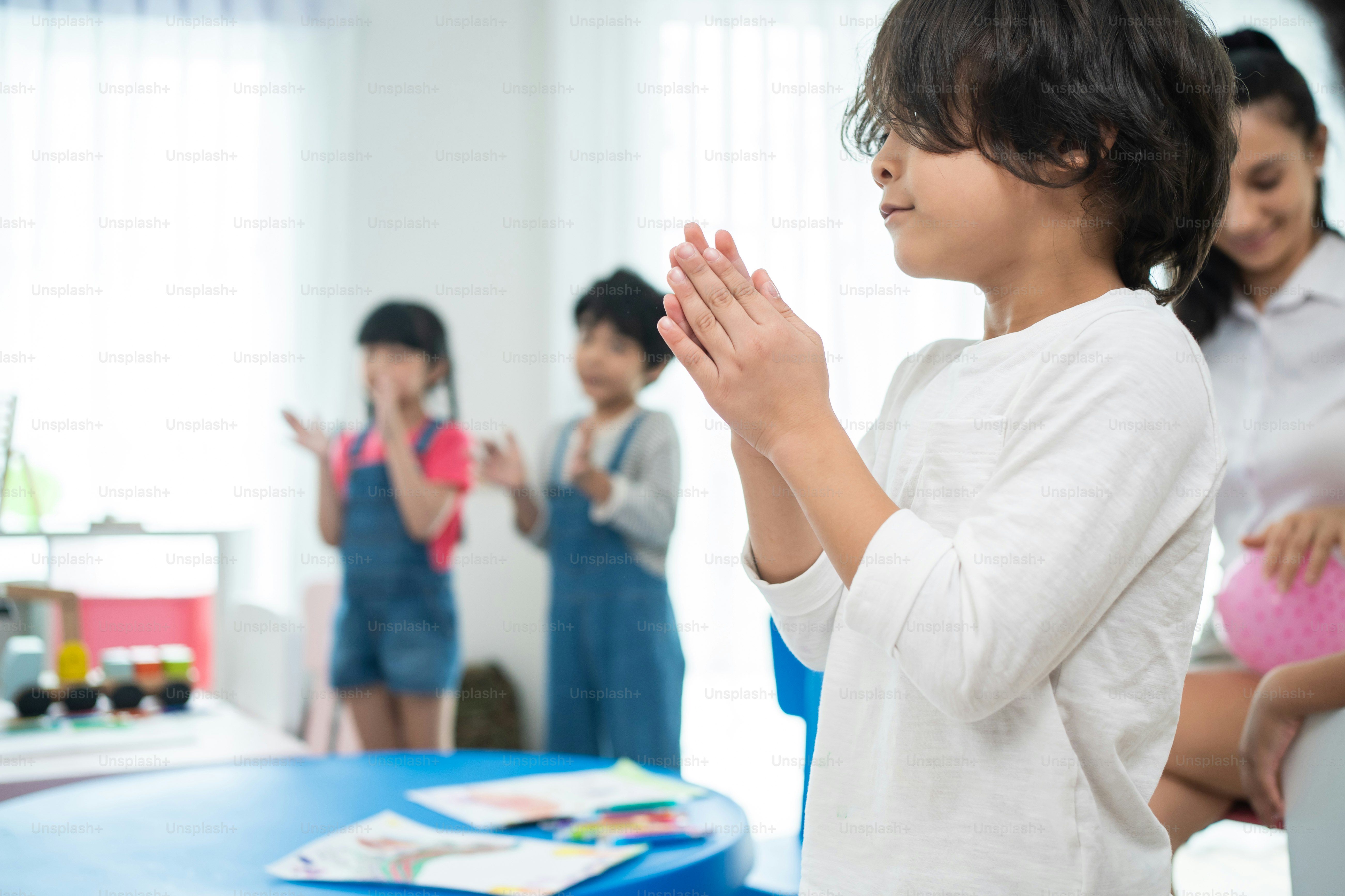 Group of Mixed race cute child standing clapping hands in classroom ...