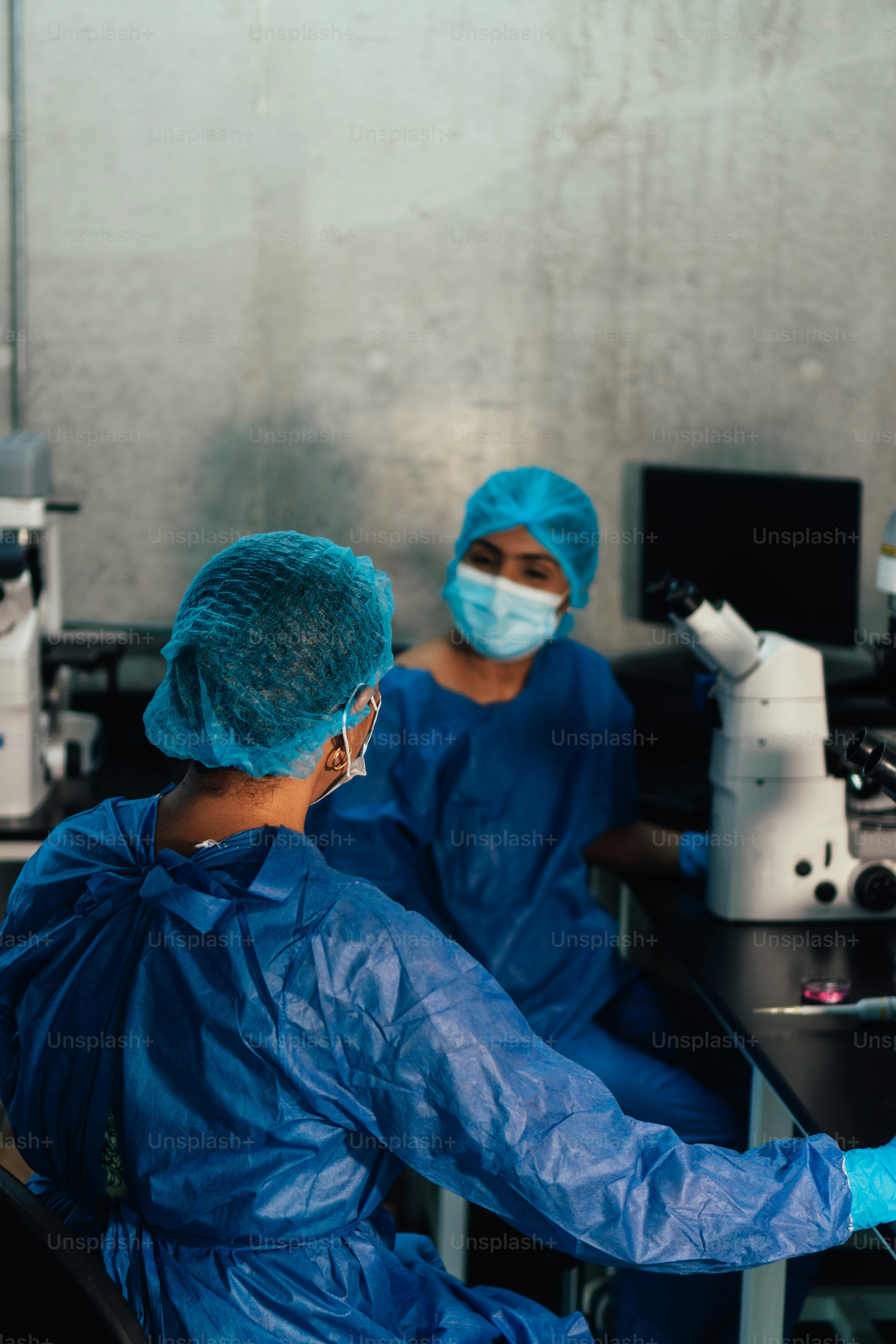 Female physicians working with a microscope. photo – Stem - topic Image ...