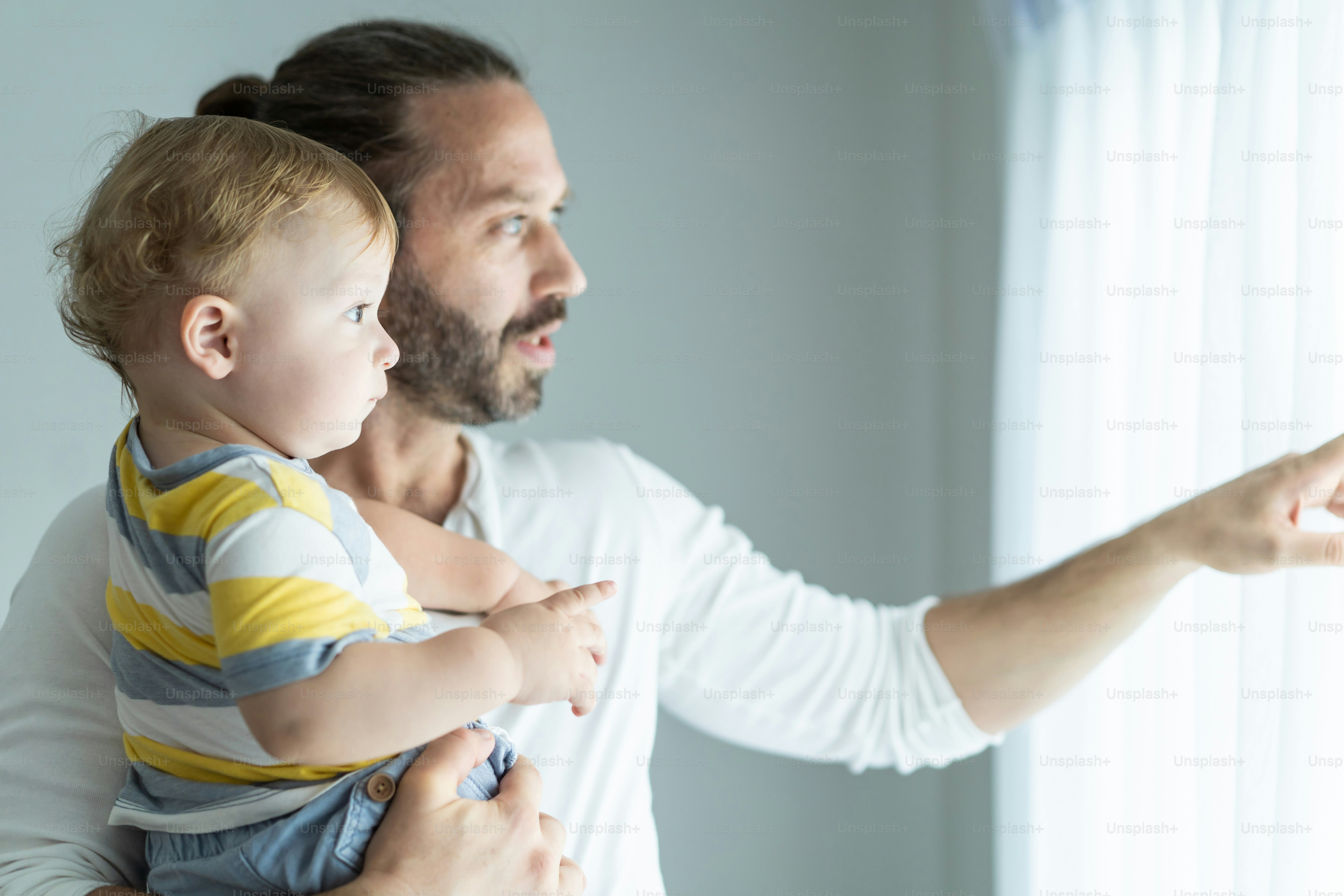 Caucasian loving father holding young baby boy child in living room ...