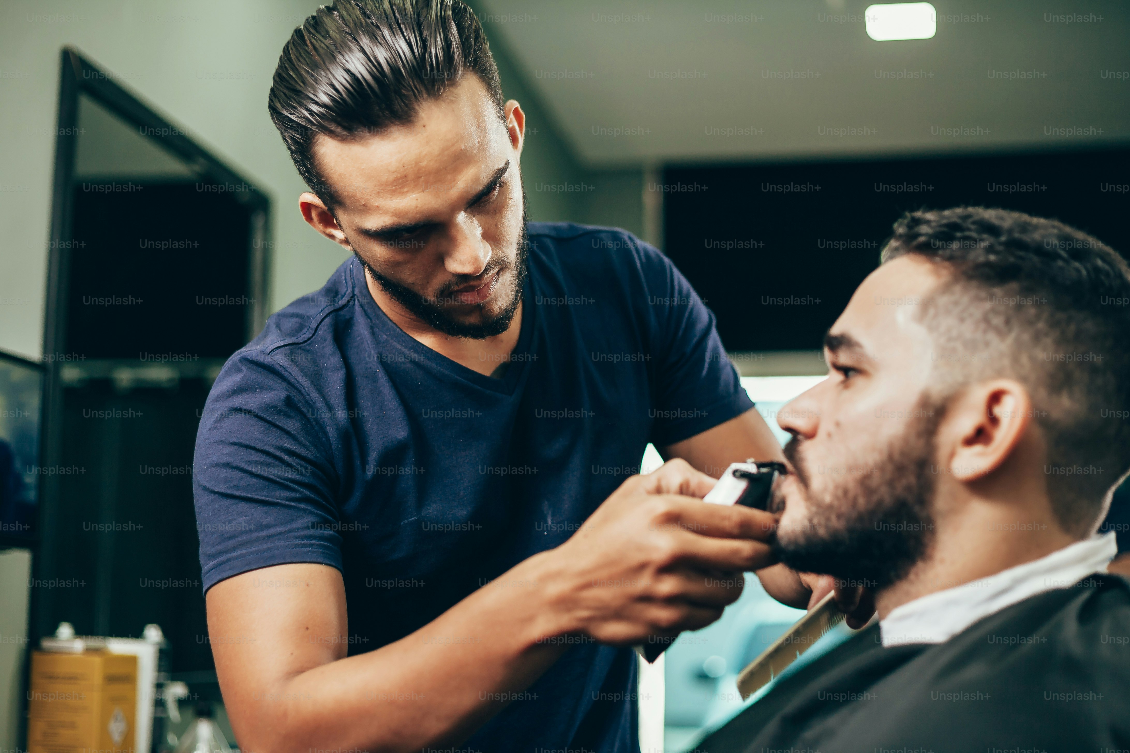 Client during beard and hair grooming in barber shop photo – Barber ...