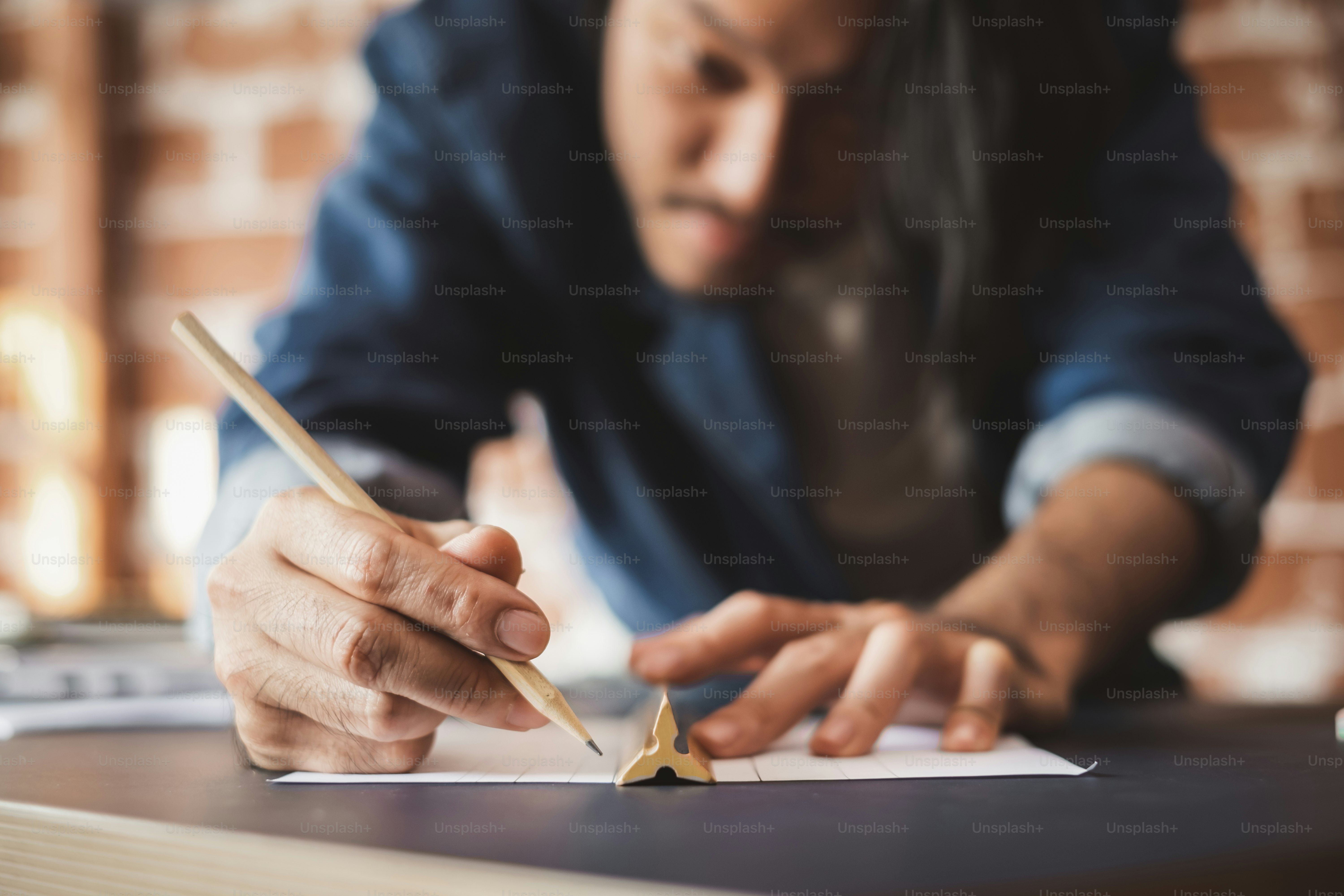 Young Asian man draft a drawing plan for artwork, architect ...