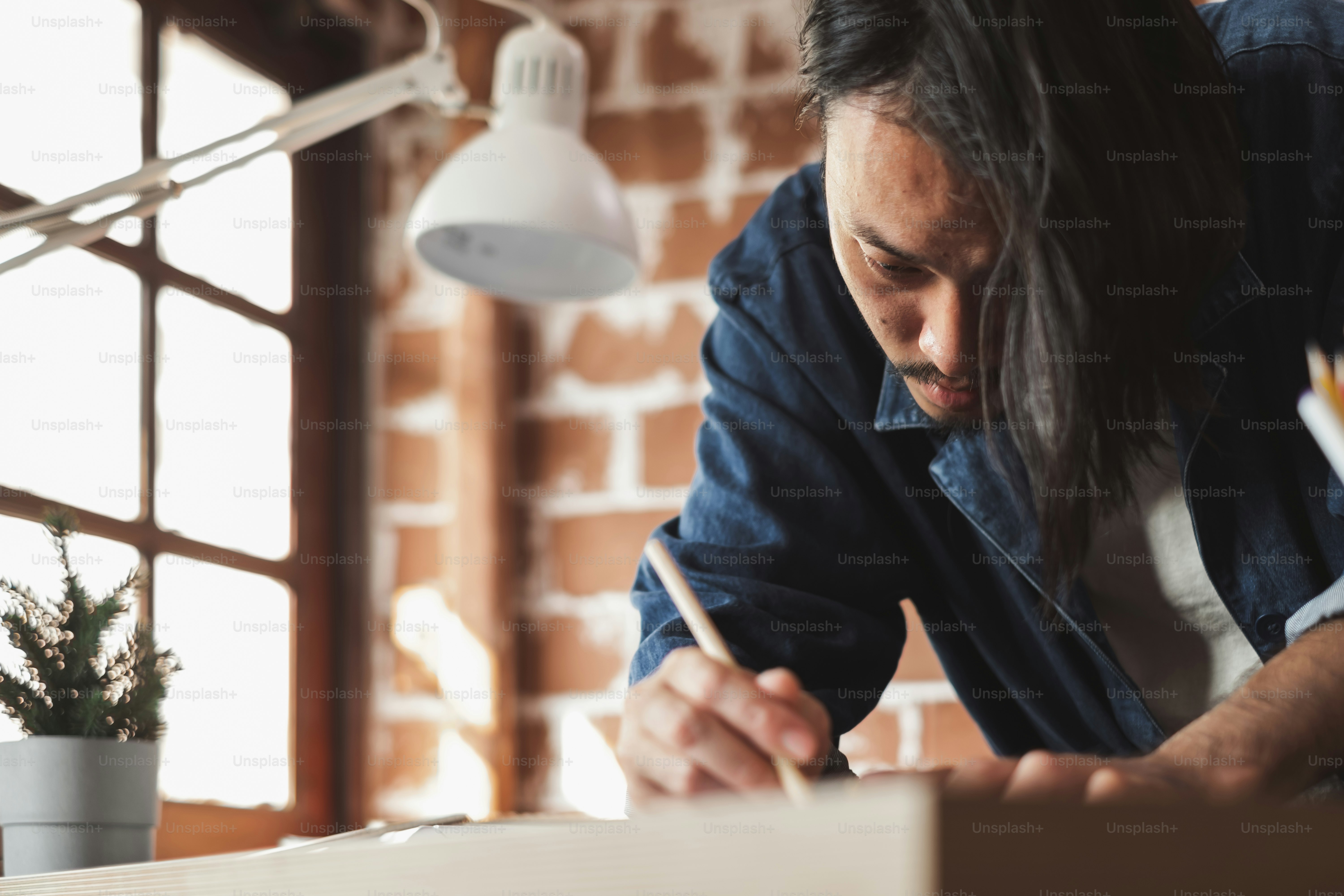 Young Asian man draft a drawing plan for artwork, architect ...