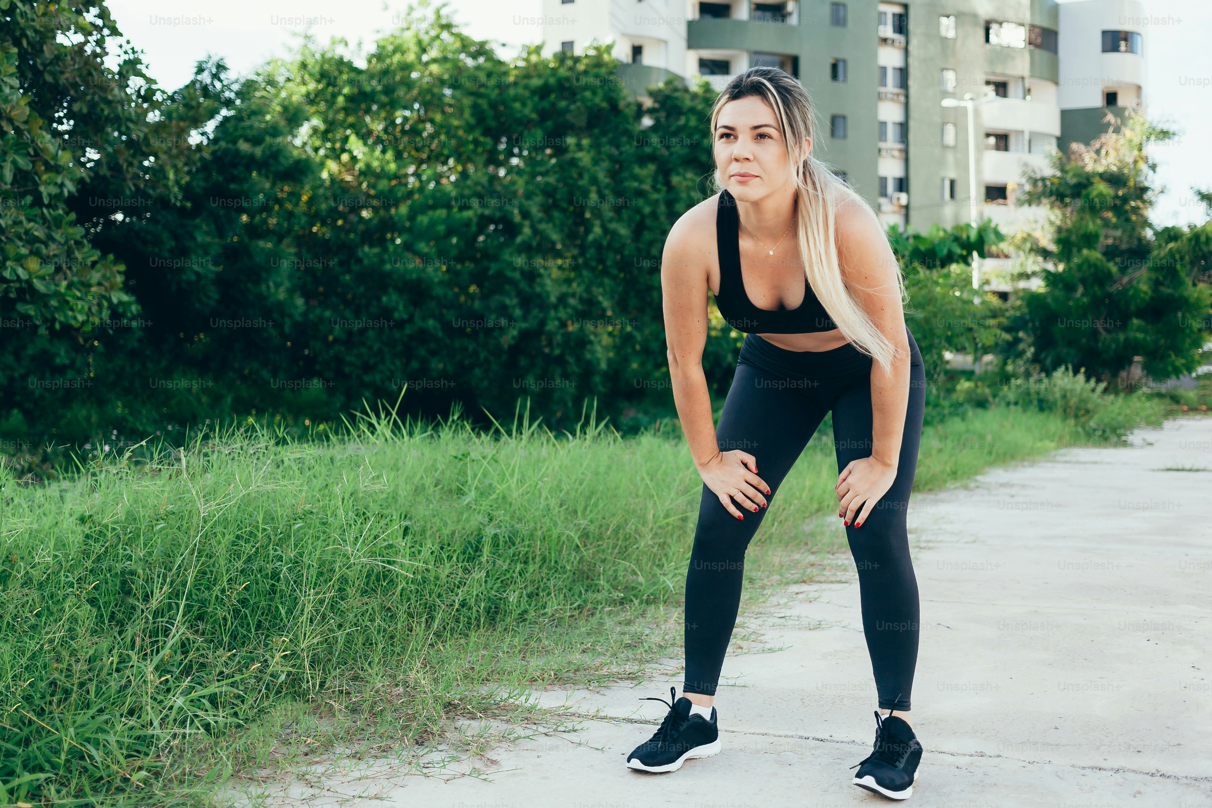 Tired woman runner taking a rest after running hard photo – Latinos ...