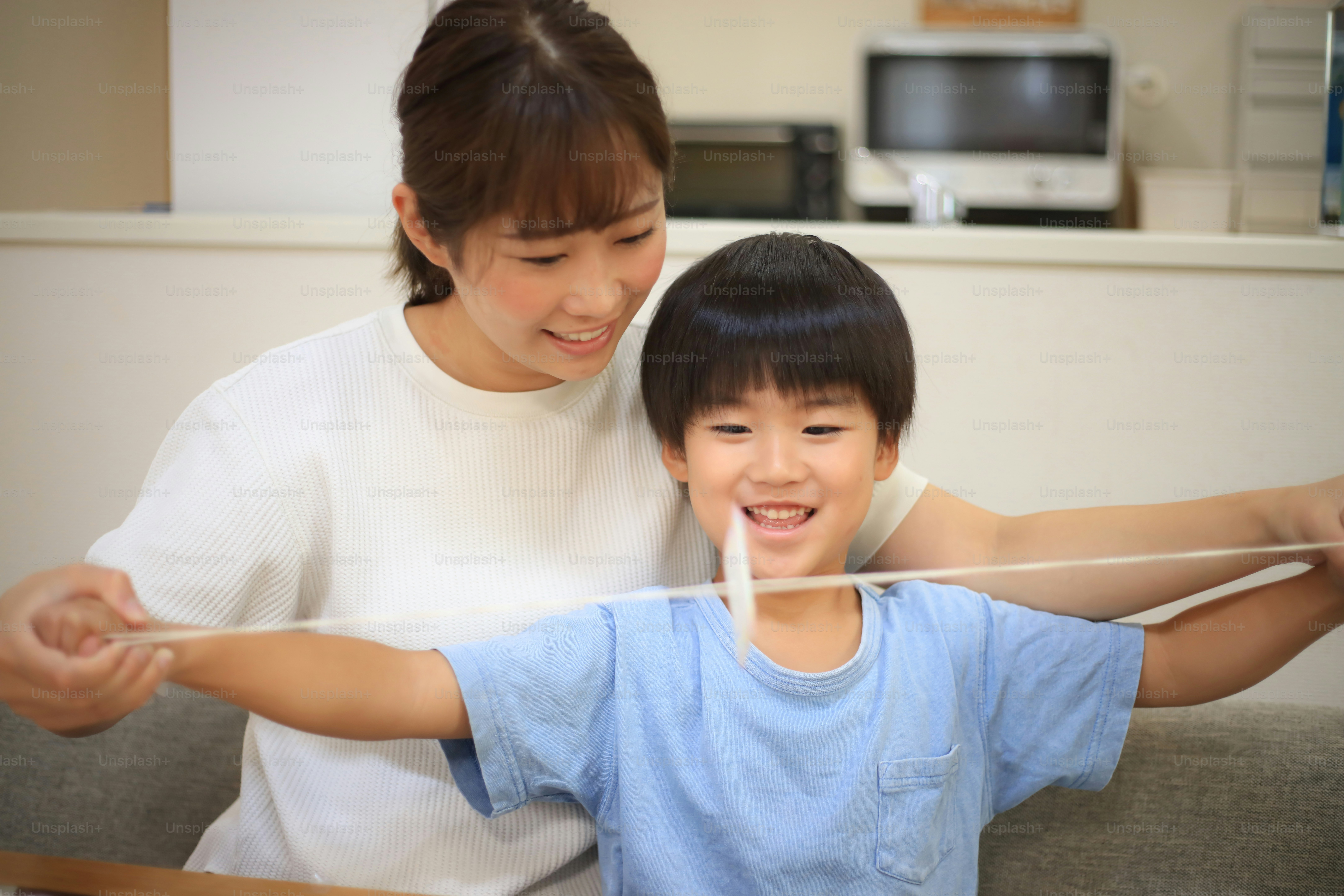 Parents and children playing with Button whirligigs photo – Drink ...