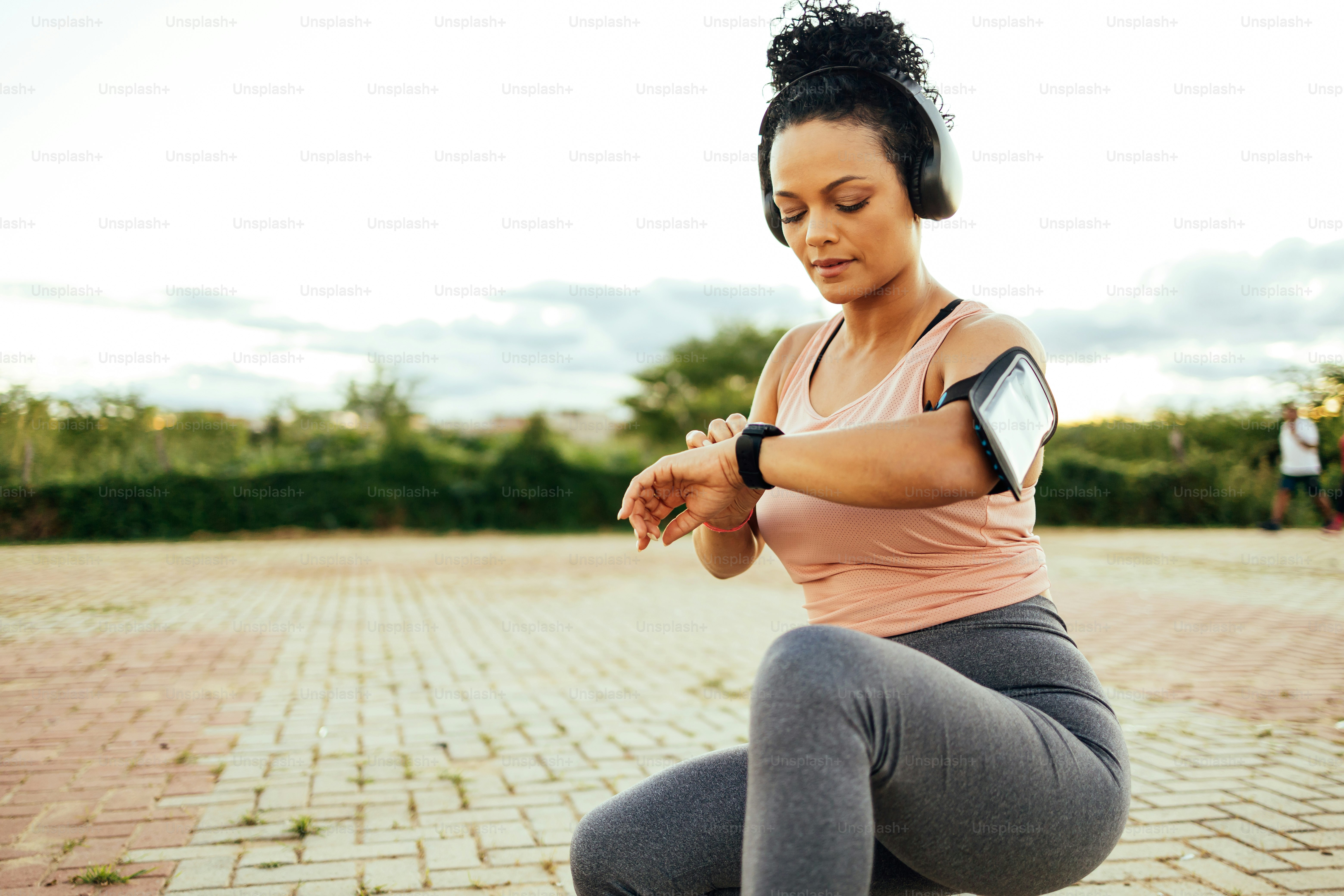Portrait of athlete woman resting after work out outdoors. photo ...