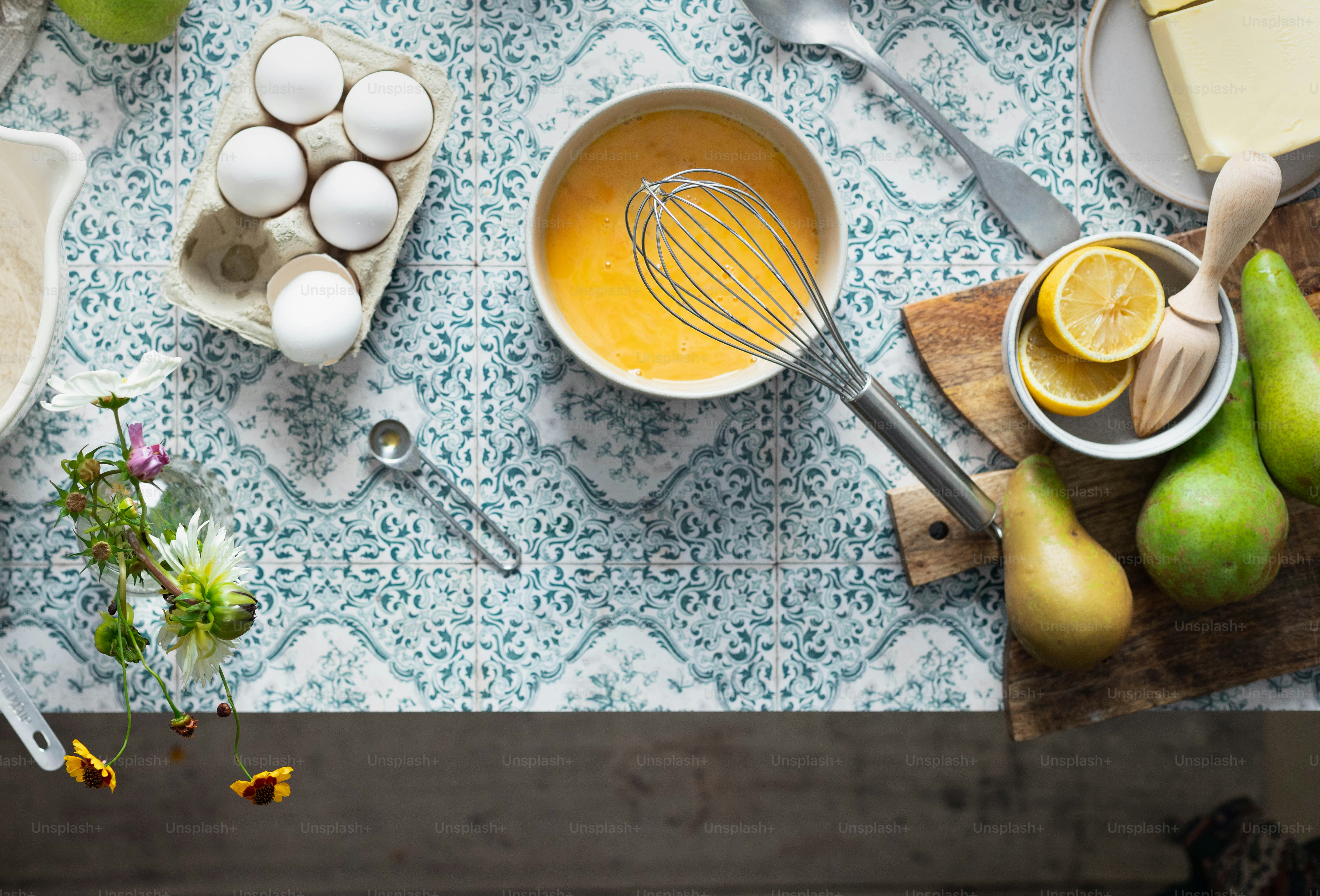 A table topped with bowls of food and a whisk photo – Cooking Image on ...