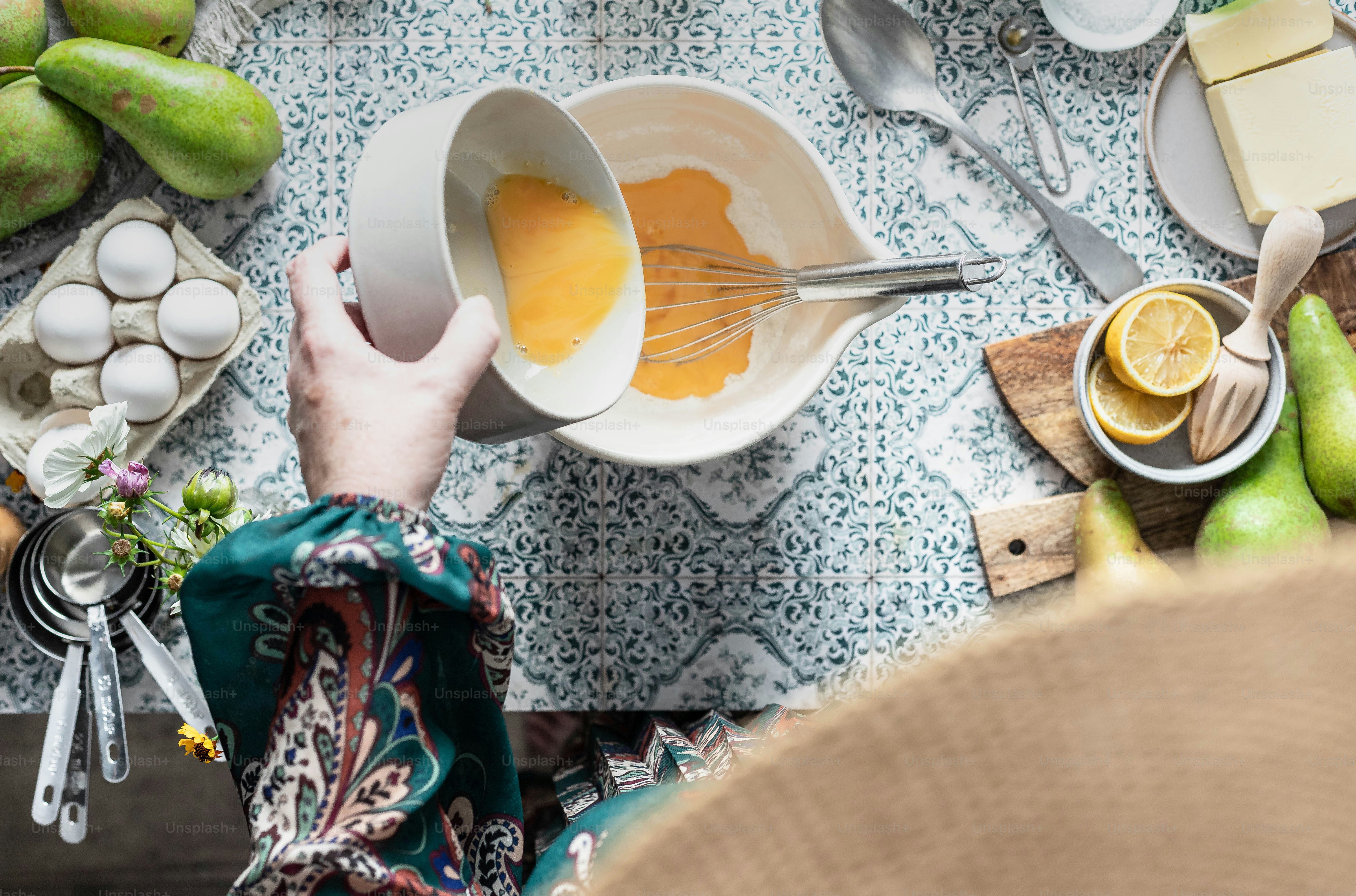 A person mixing a mixture in a bowl photo – Whisking Image on Unsplash