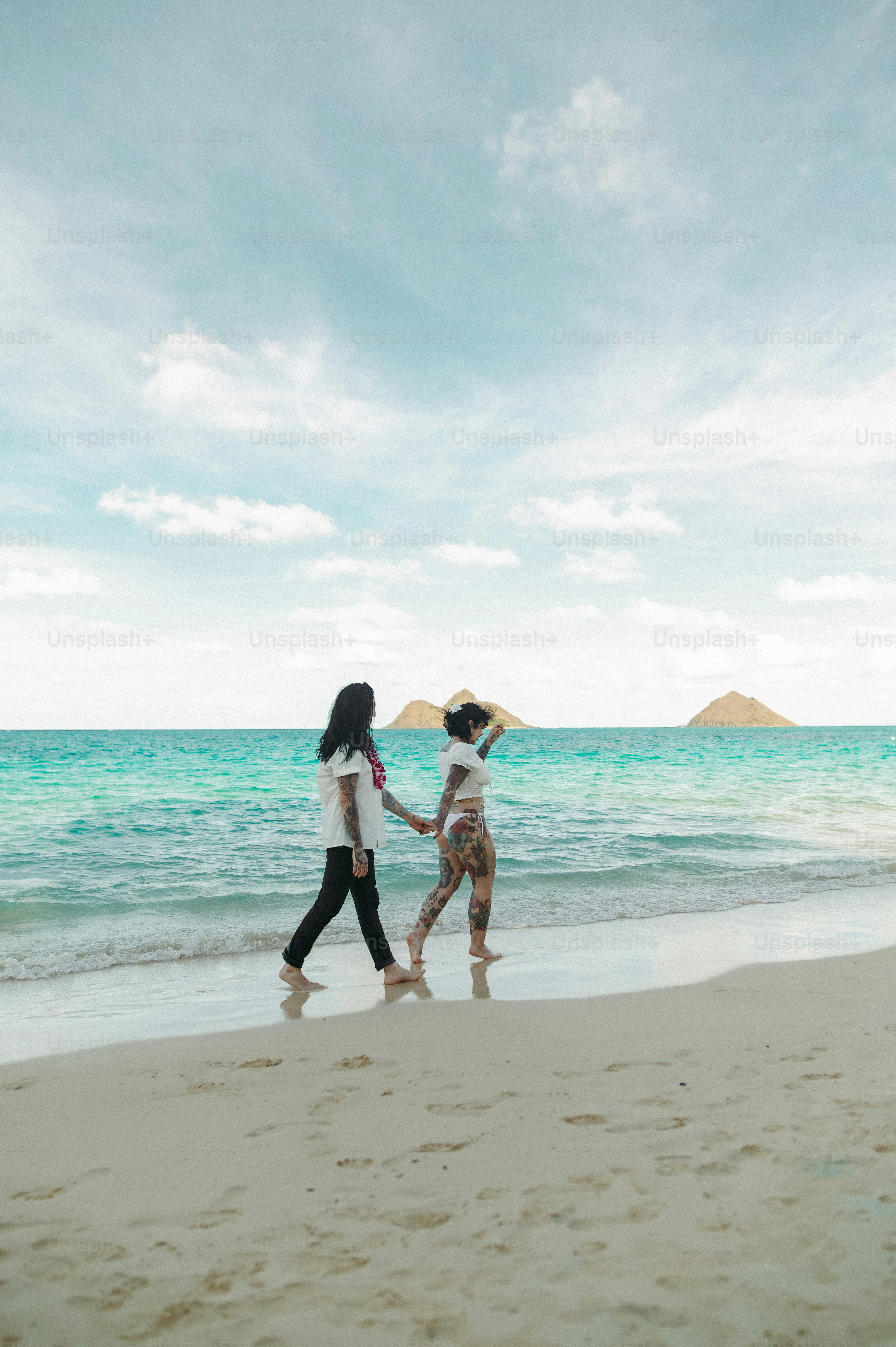 Deux femmes marchant sur une plage se tenant la main photo – Femme ...