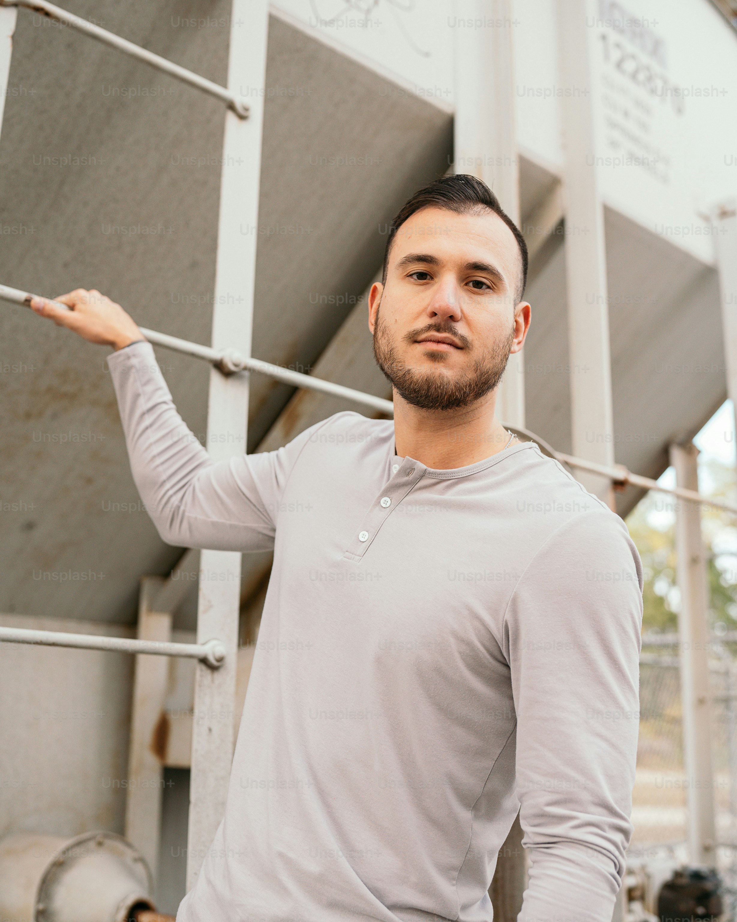 A man standing in front of a metal structure photo – Man Image on Unsplash