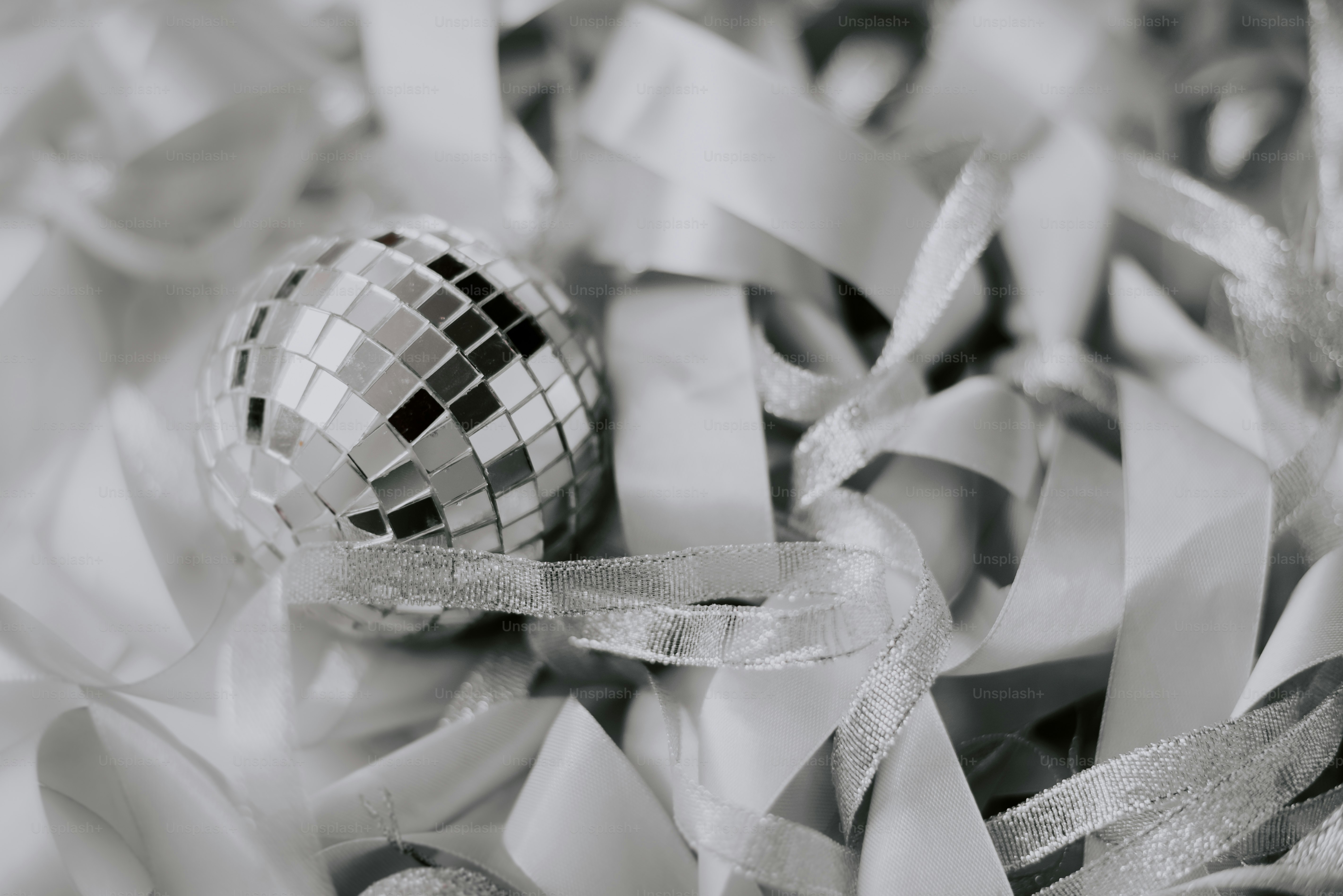 A disco ball surrounded by ribbons and streamers photo – Silver color ...