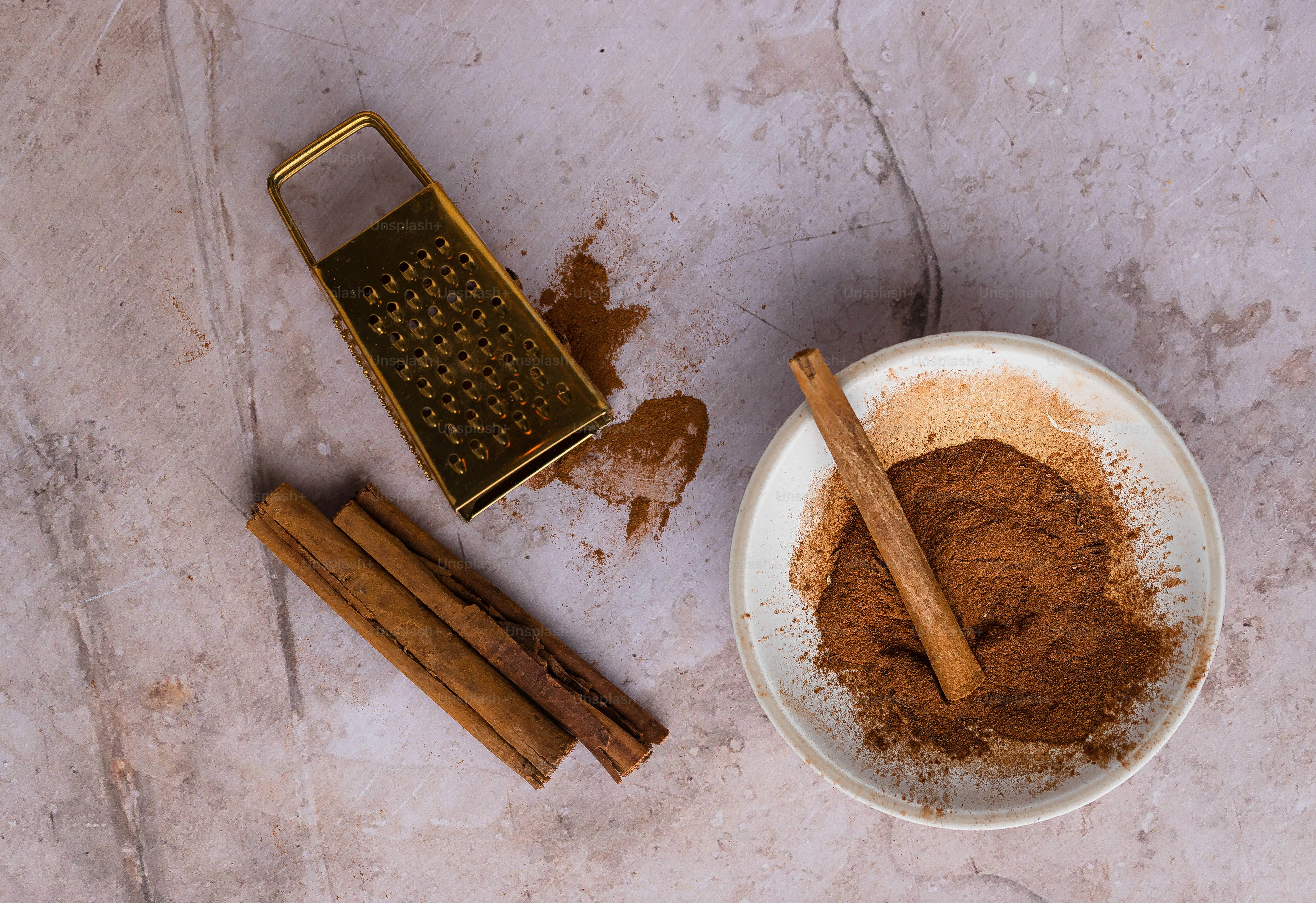 A bowl of cinnamon powder and cinnamon sticks photo – Ground spices ...