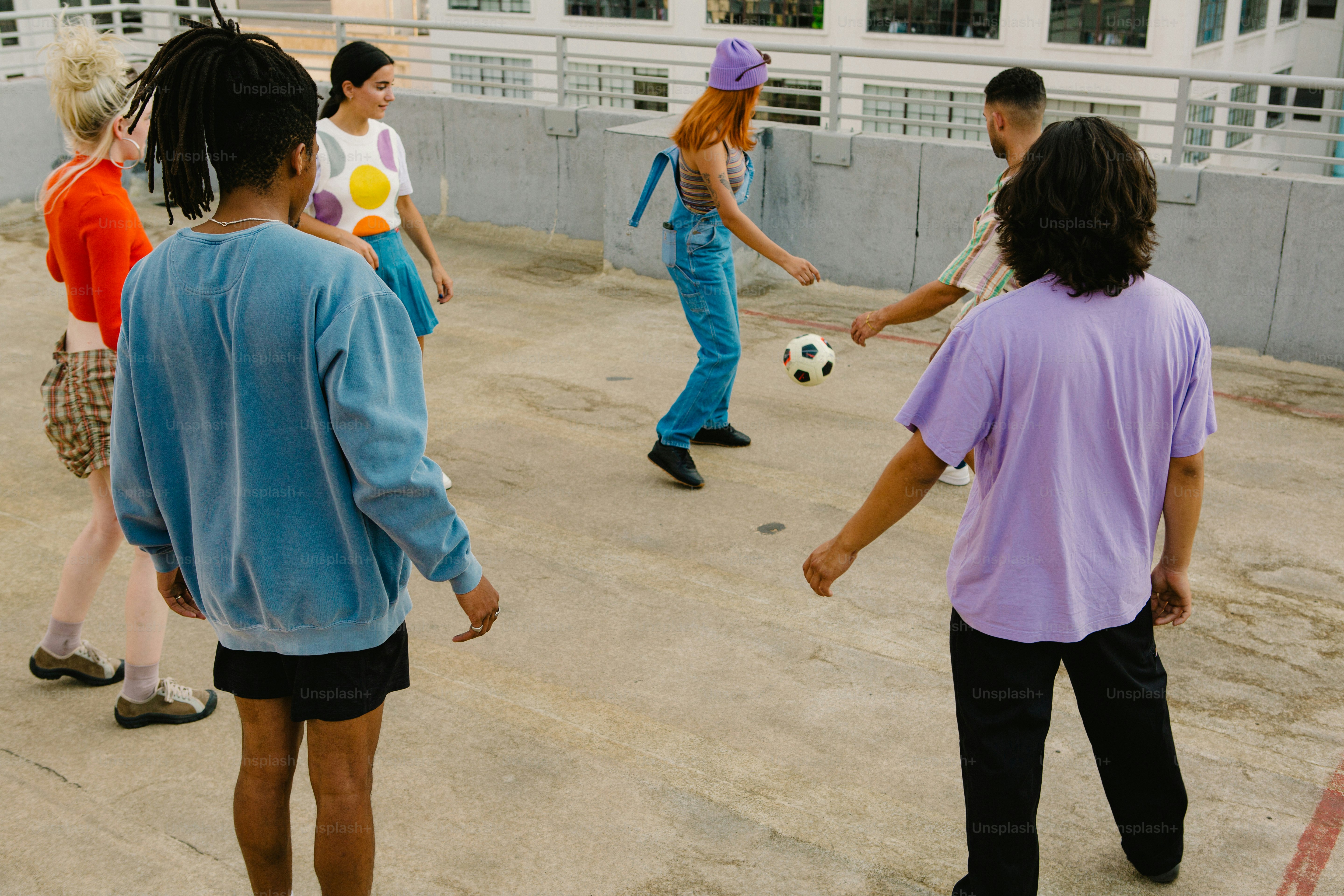 A group of people playing a game of soccer photo – Having fun Image on ...
