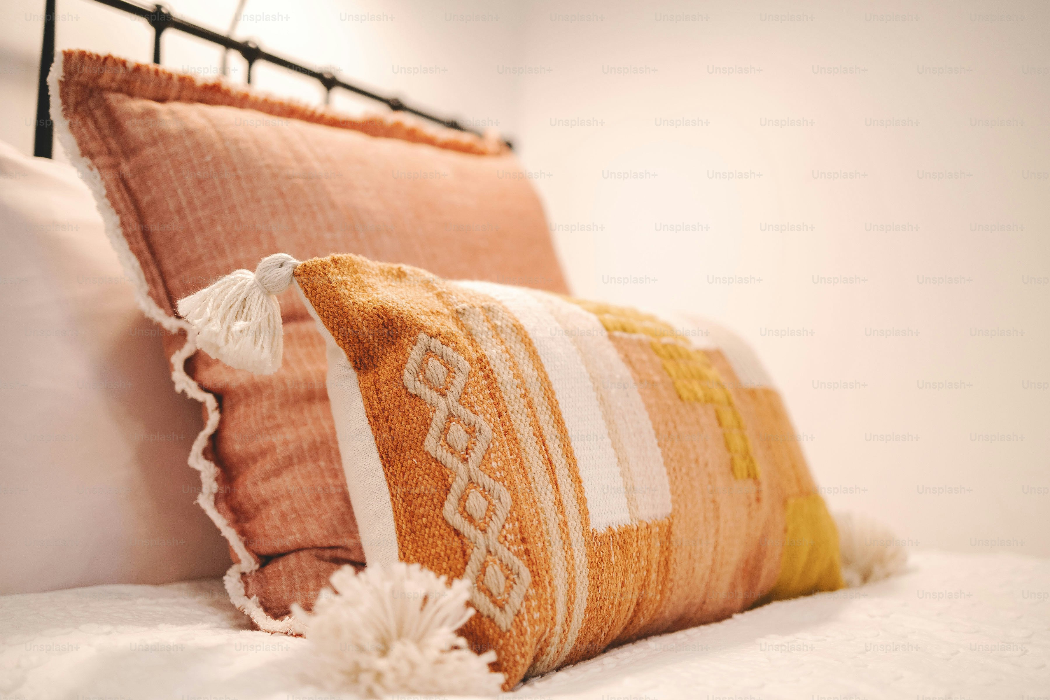 A bedroom with a bed, night stand, and nightstand photo – Cushions on ...