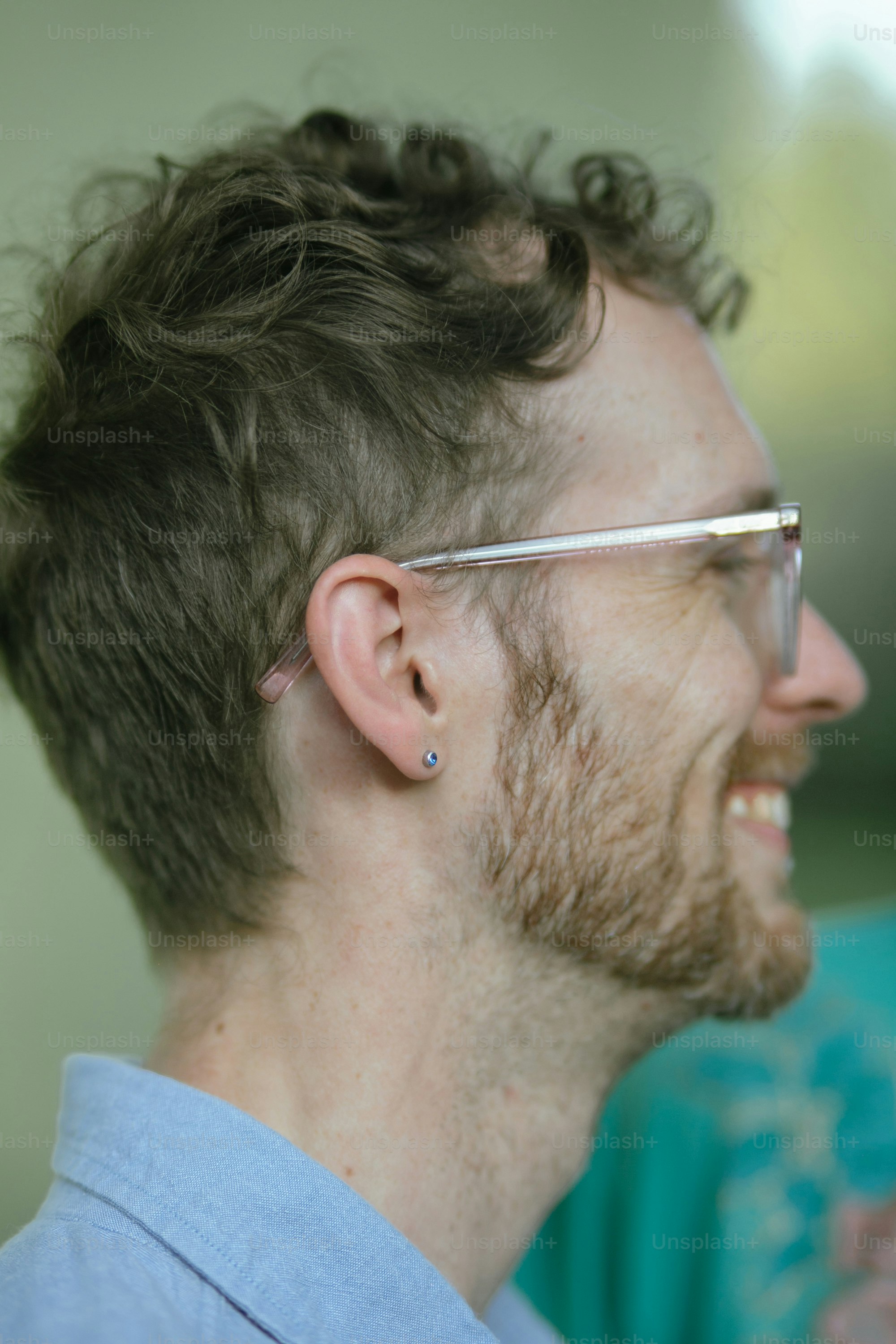 A man with a beard and glasses smiling photo – Side profile Image on ...