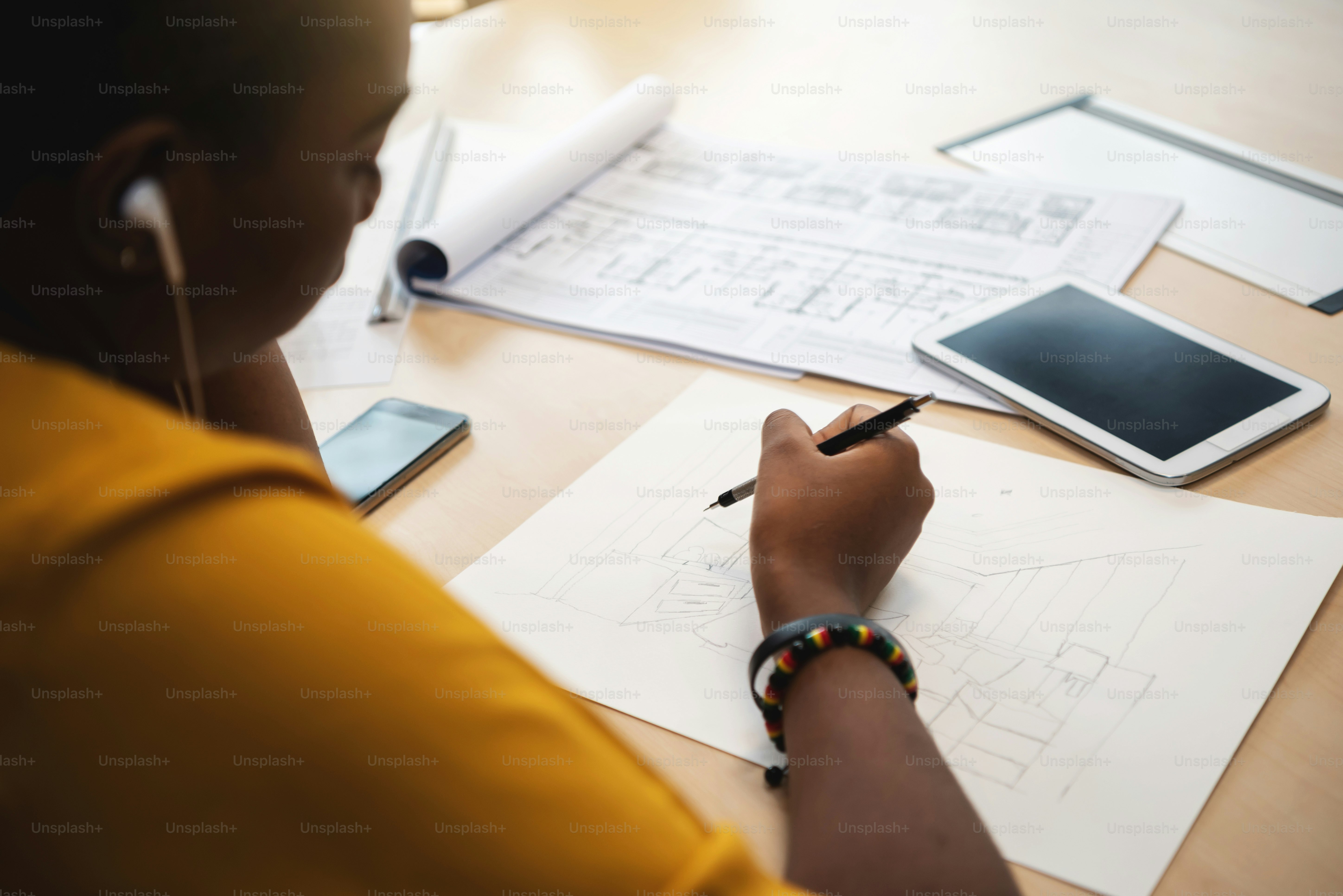 Concentrated FeMale Architect Designer working with drawing new ideas ...