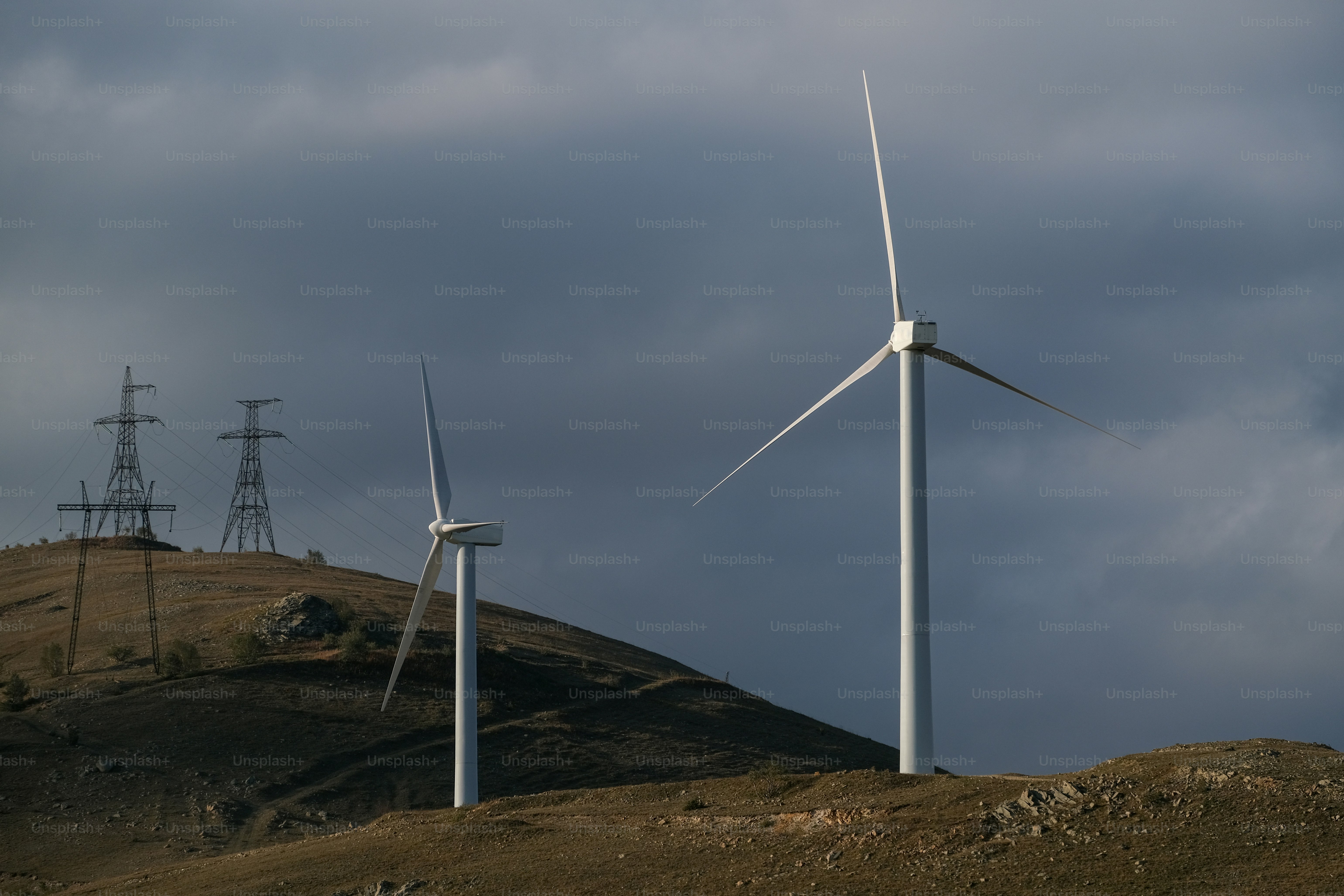 A group of wind turbines on a hill photo – Wind turbine Image on Unsplash