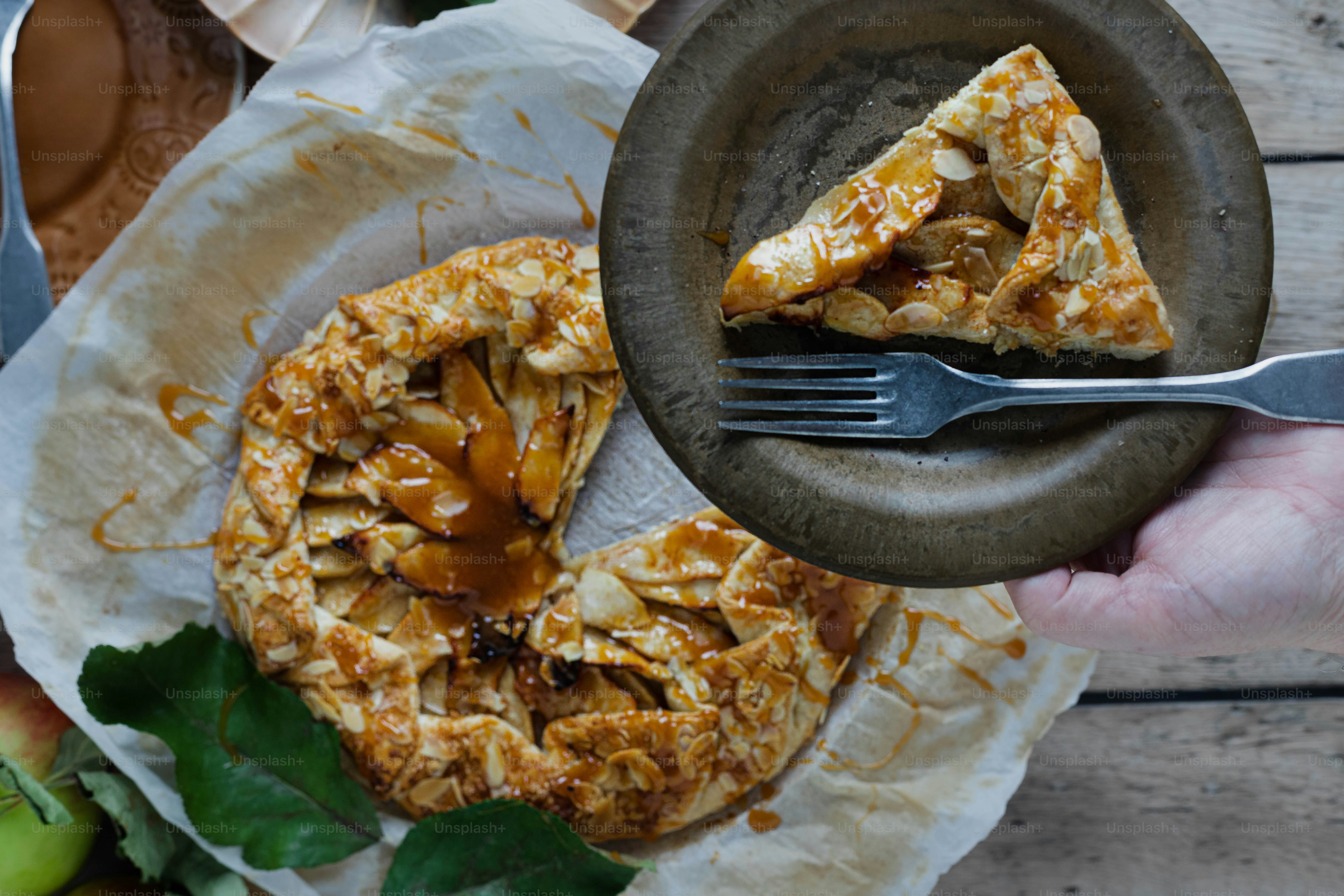 A person holding a piece of pie in their hand photo – Food Image on ...