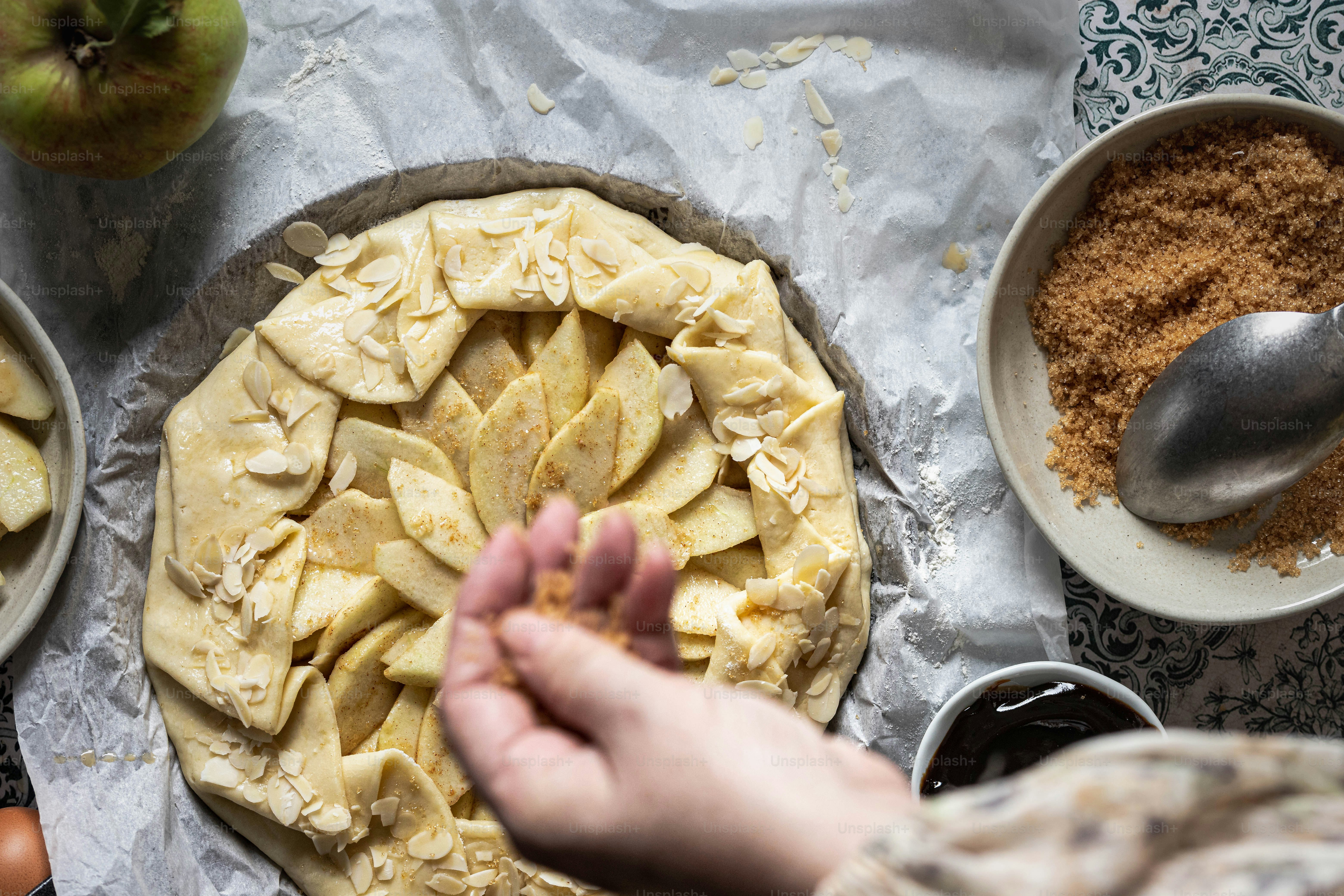 A person putting toppings on a pie crust photo – Food Image on Unsplash