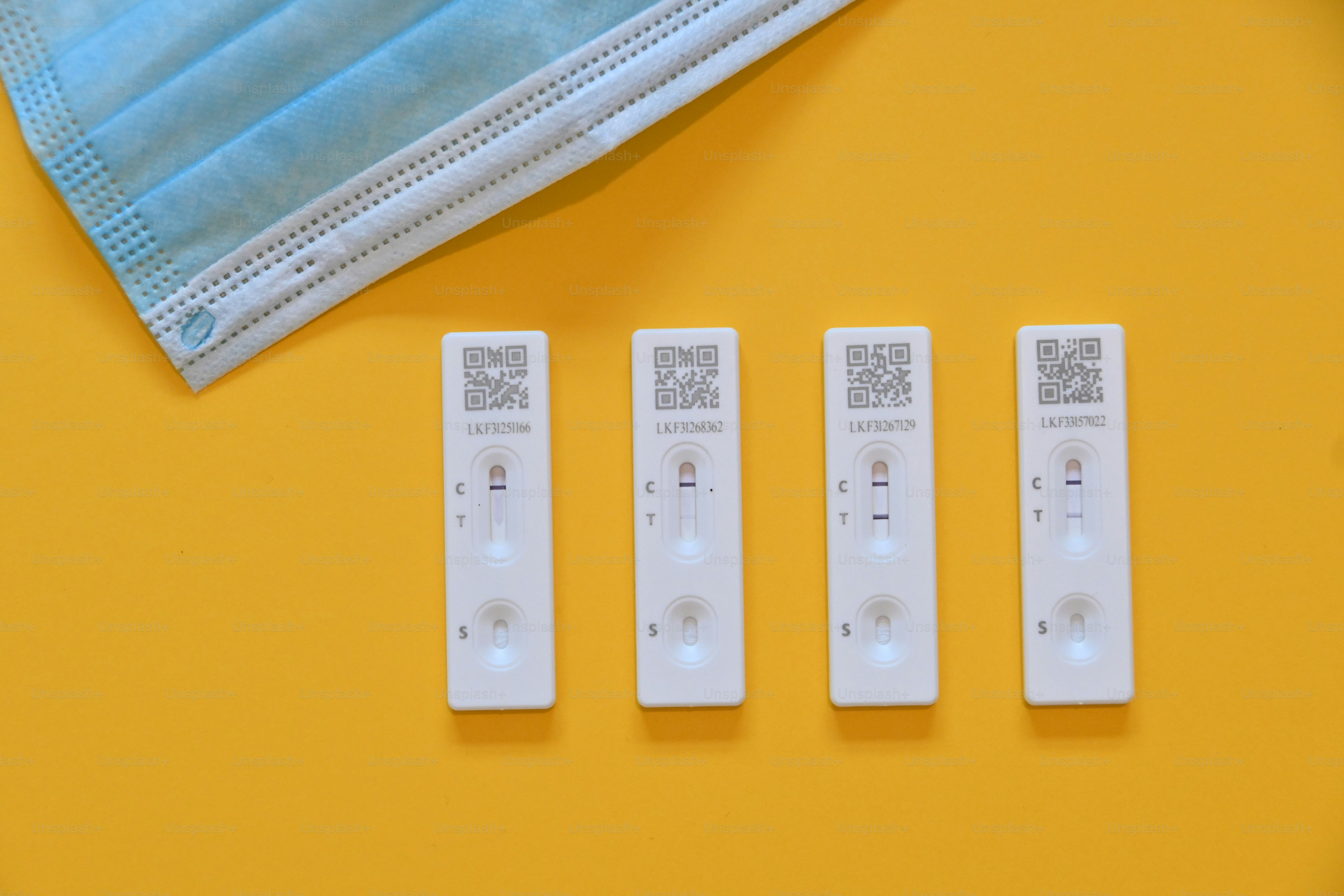 Three disposable face masks and three electrical outlets photo – Covid ...