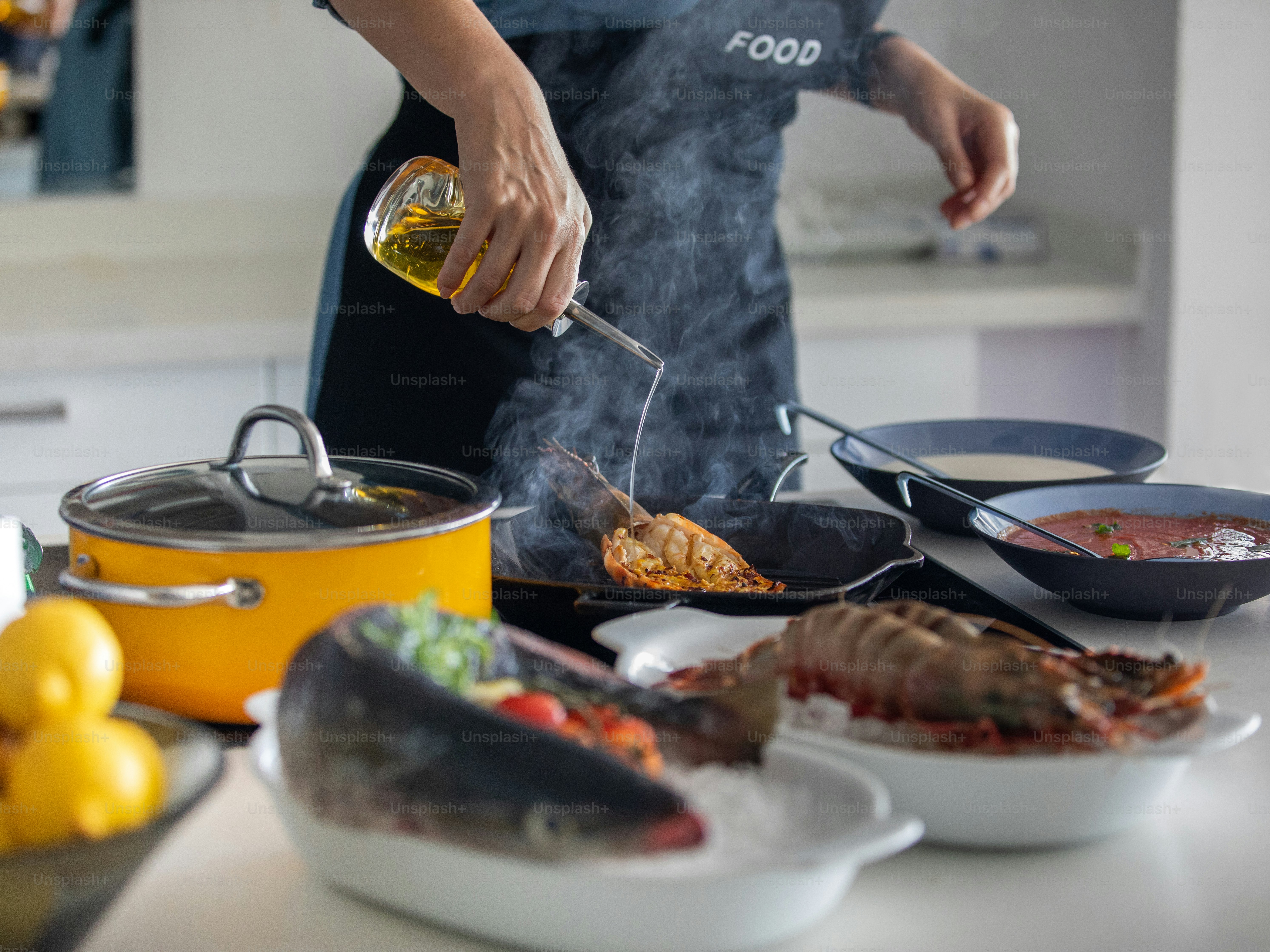 A person cooking food on a stove top photo – Cooking oil Image on Unsplash