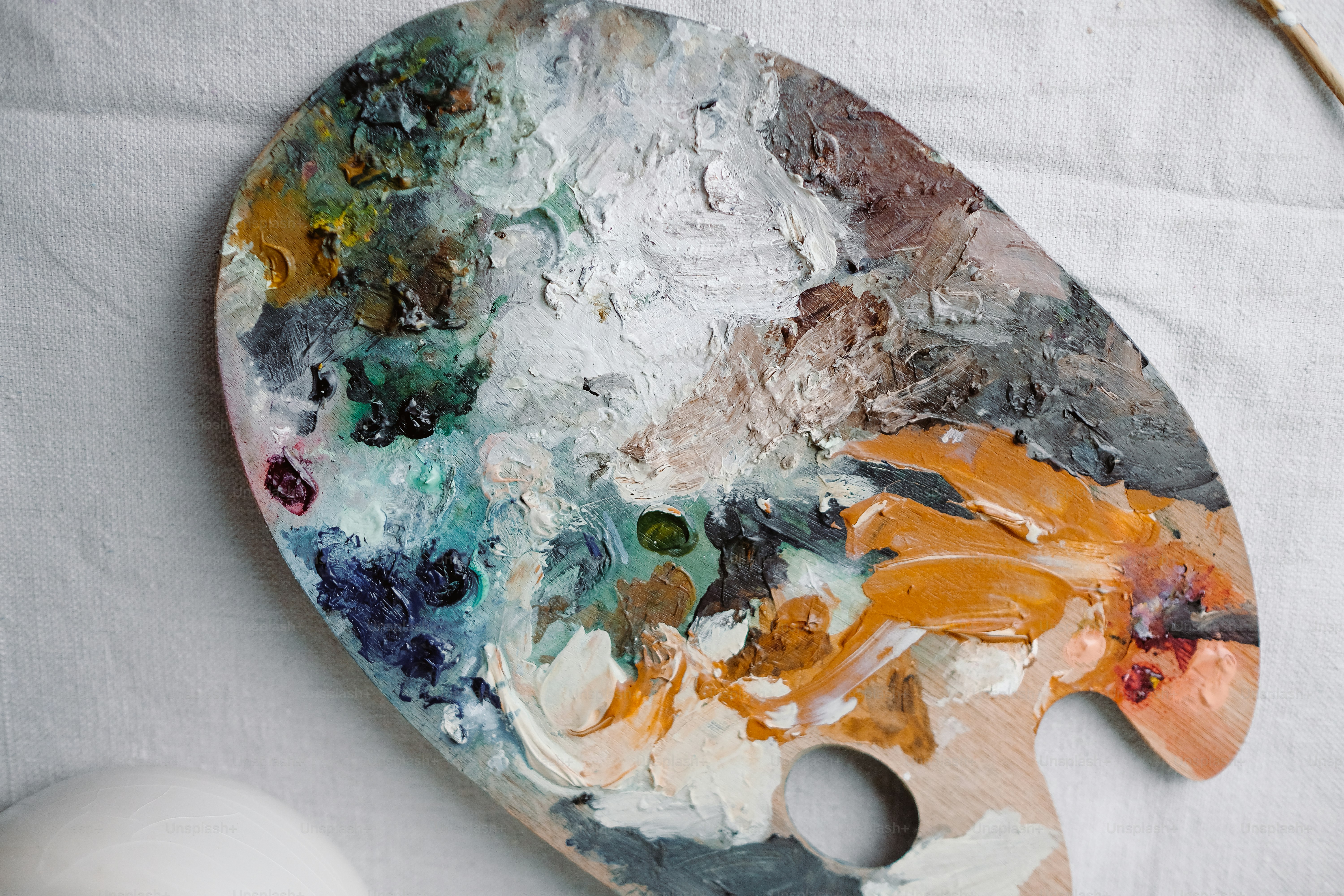 A palette with paint, brushes, and other art supplies photo – Paint ...