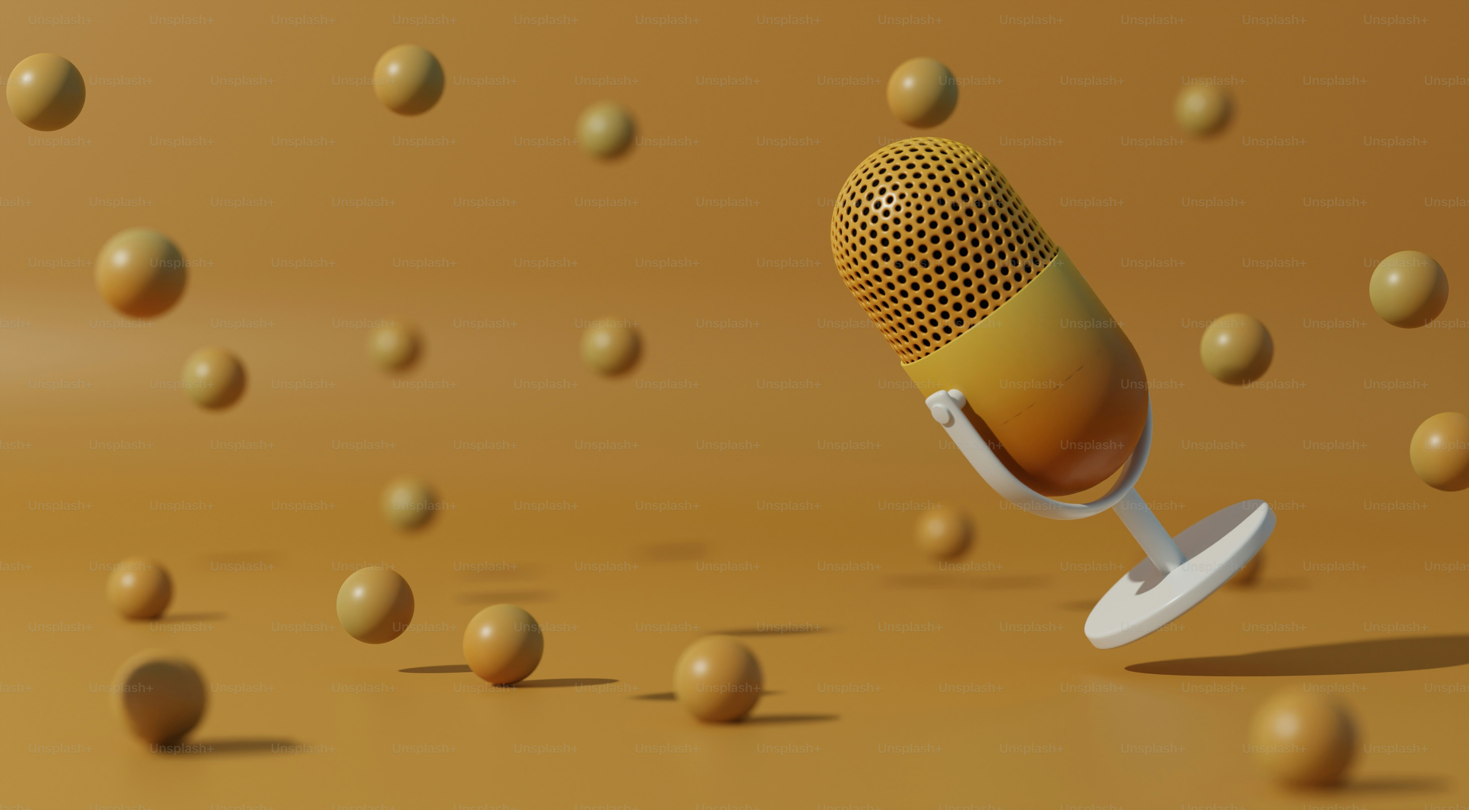 A yellow microphone is surrounded by small balls photo – Background ...