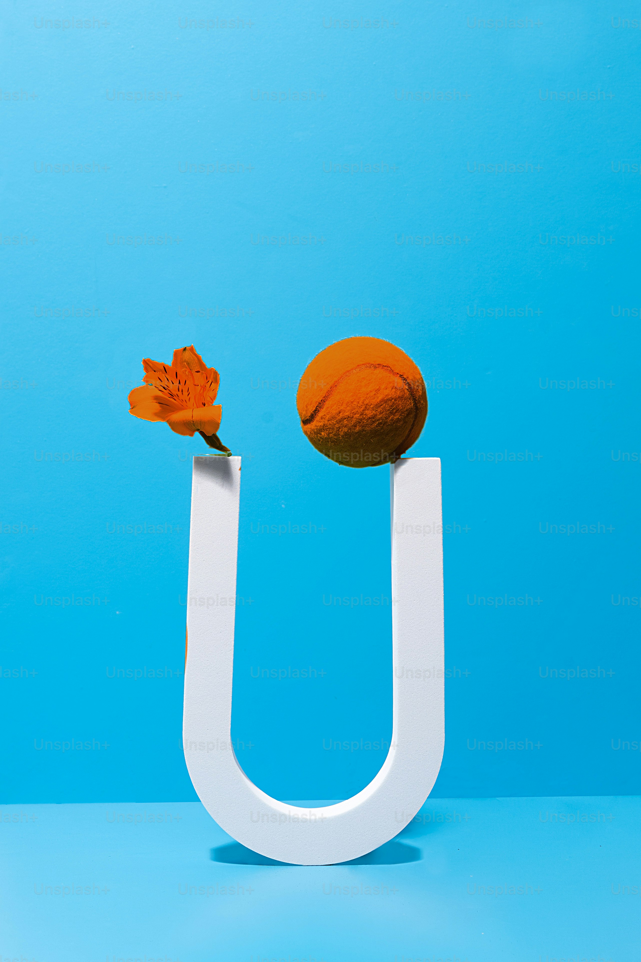 An orange object sitting on top of a white object photo – Minimal Image ...