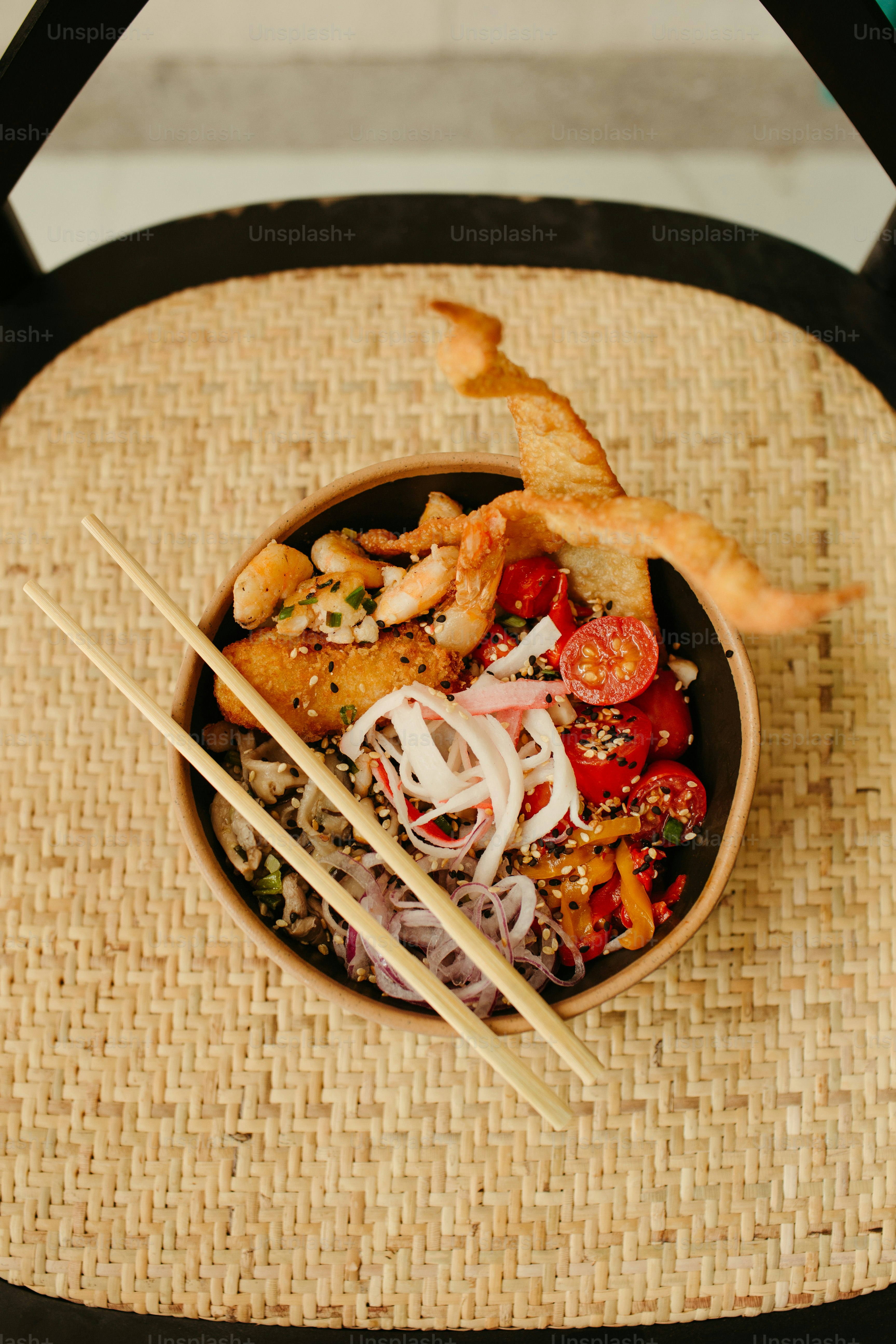 A bowl of food with chopsticks on a chair photo – Salad Image on Unsplash