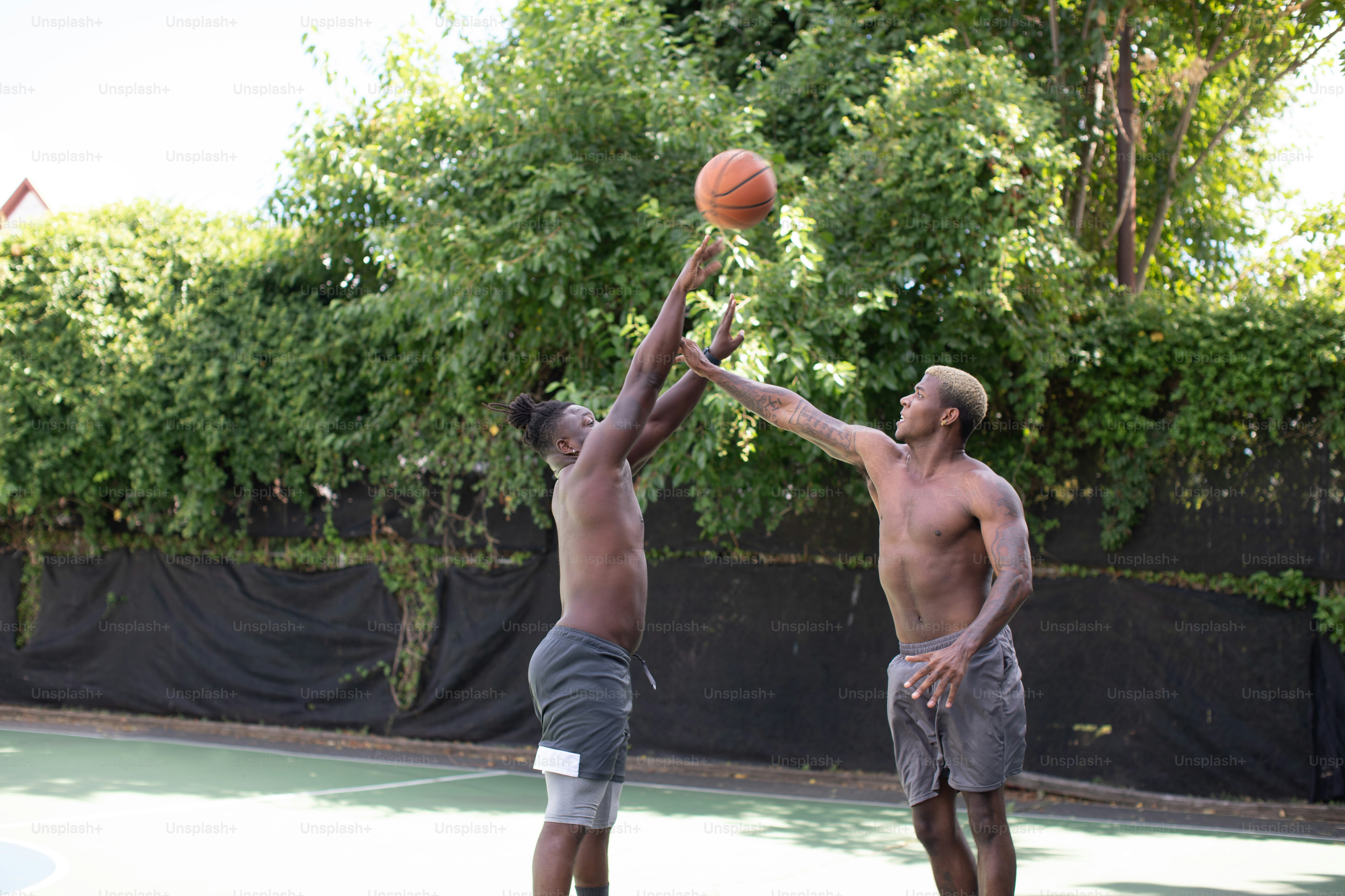 A couple of men playing a game of basketball photo – Basketball Image ...