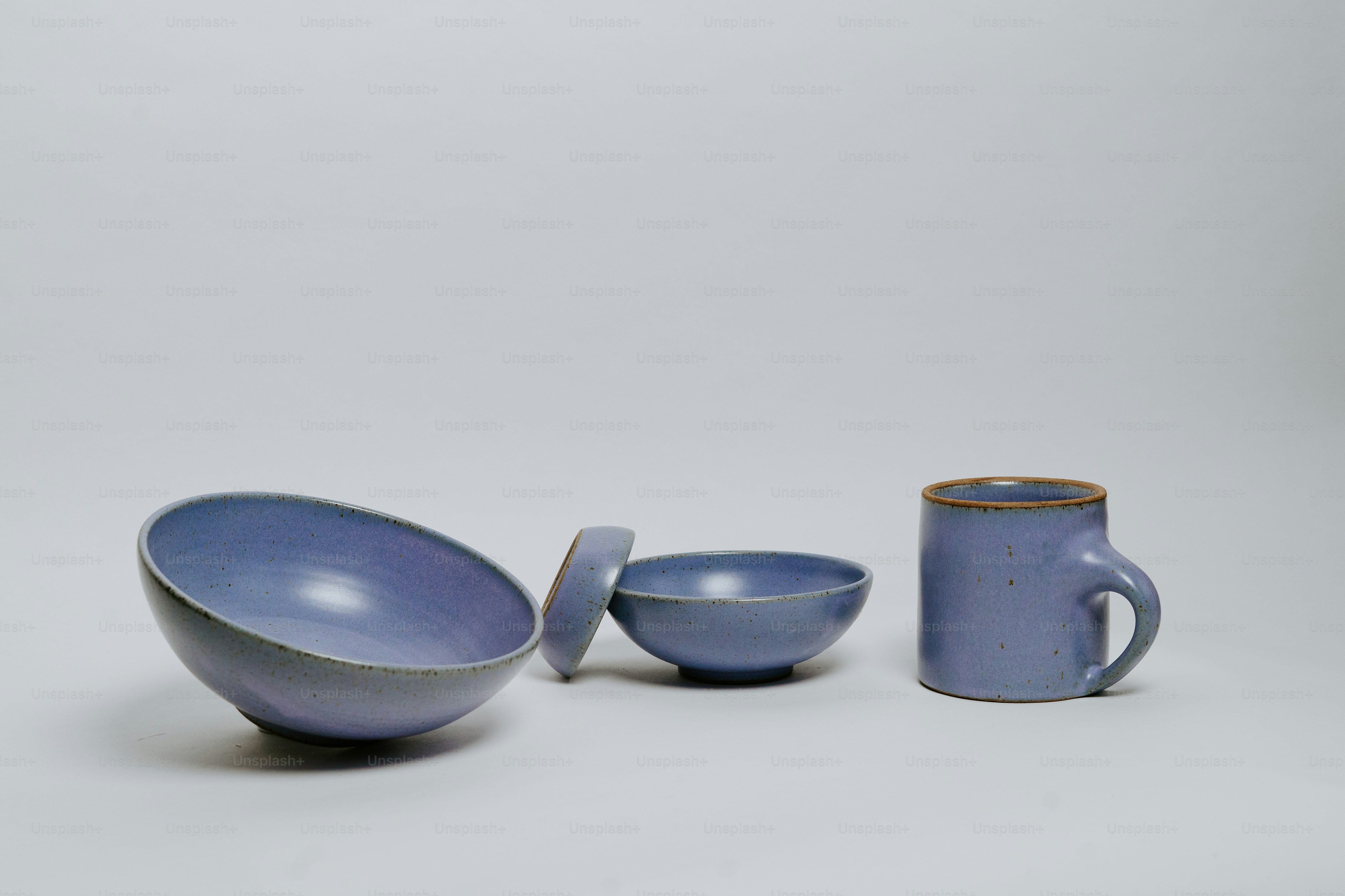 A couple of bowls and a cup sitting next to each other photo – Ceramics ...