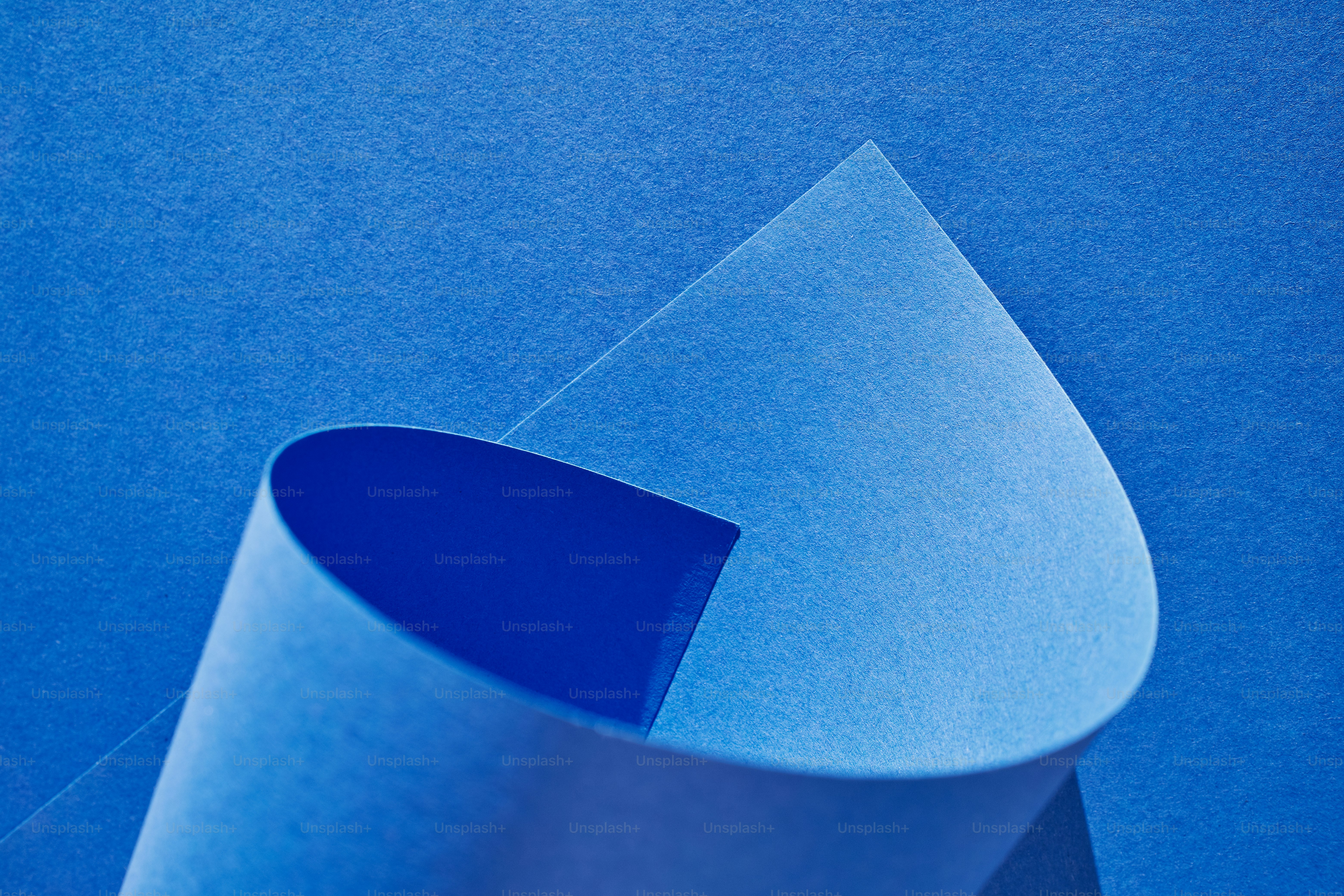 A close up of a piece of blue paper photo – Wallpaper Image on Unsplash
