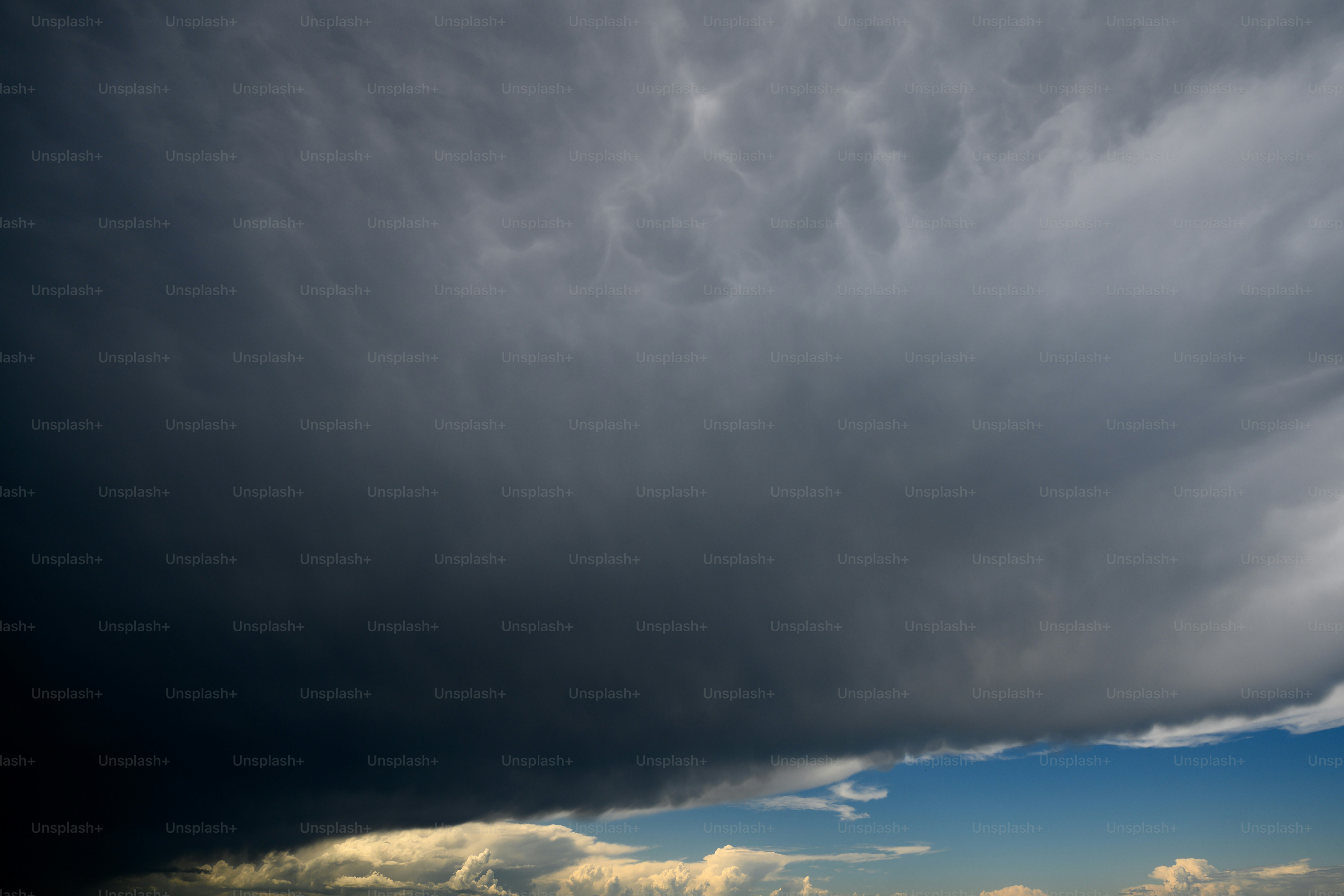 A large body of water under a cloudy sky photo – Clouds Image on Unsplash