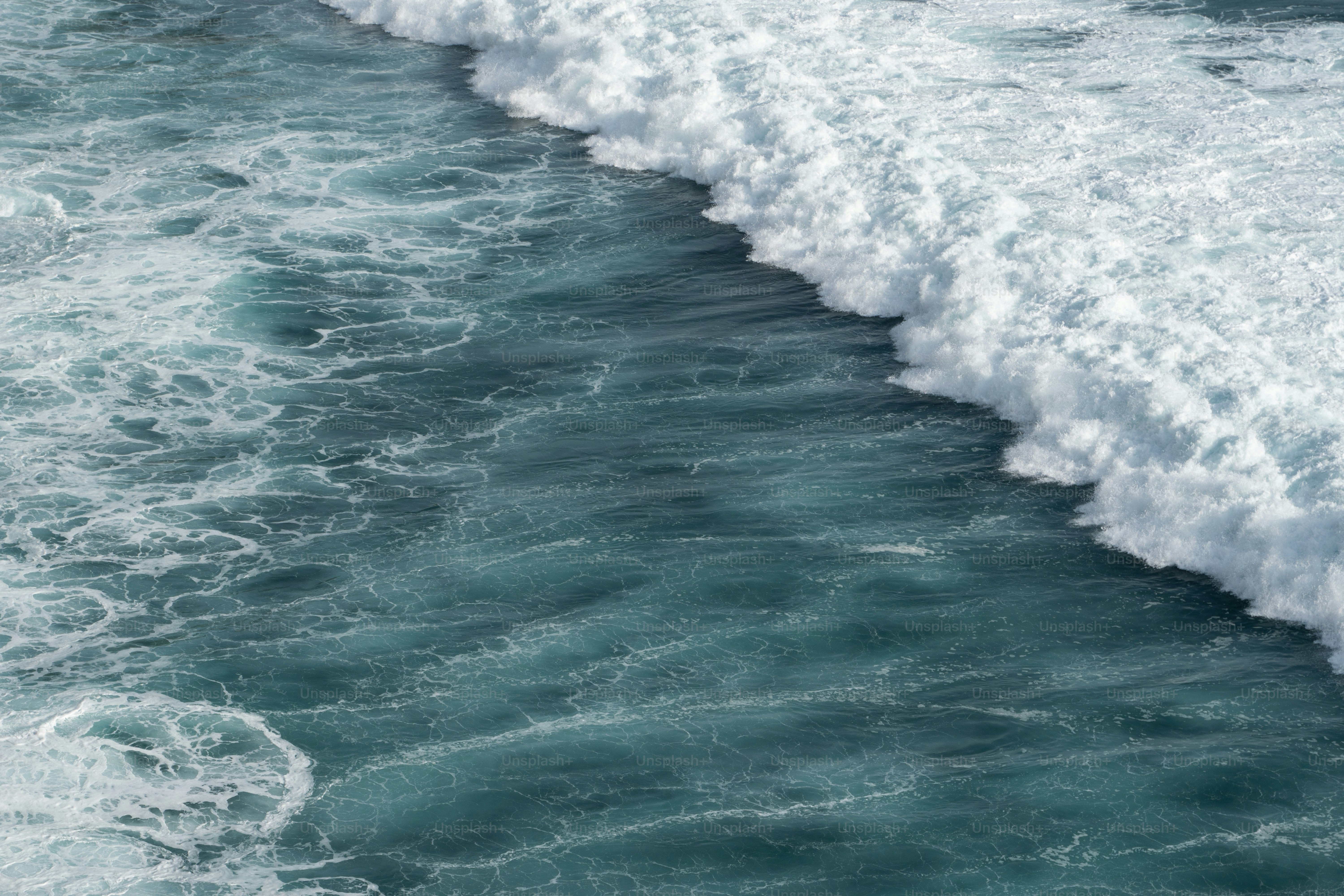 A large wave breaking over the top of the ocean photo – Bali Image on ...