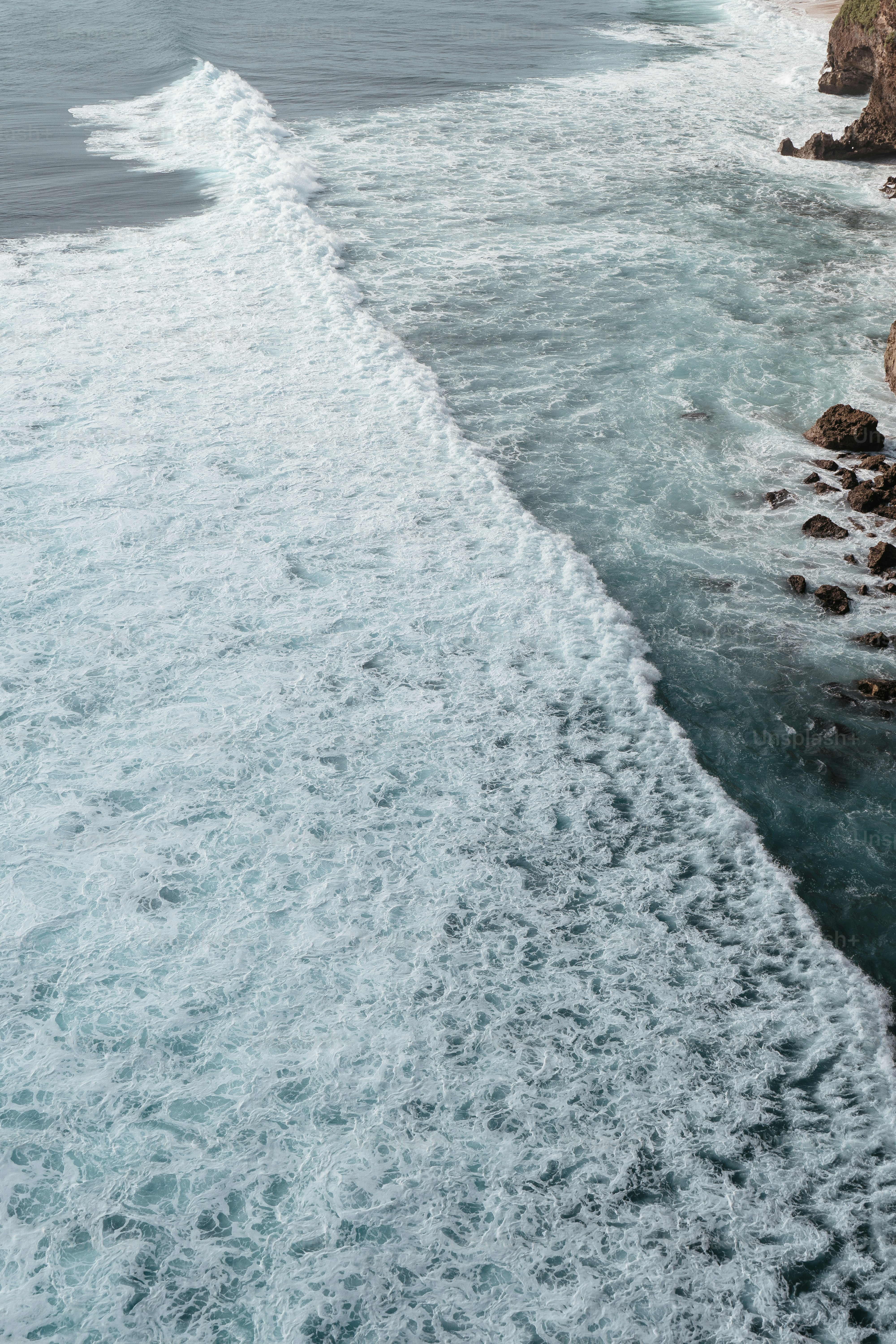 A large wave breaking over the top of the ocean photo – Sea Image on ...