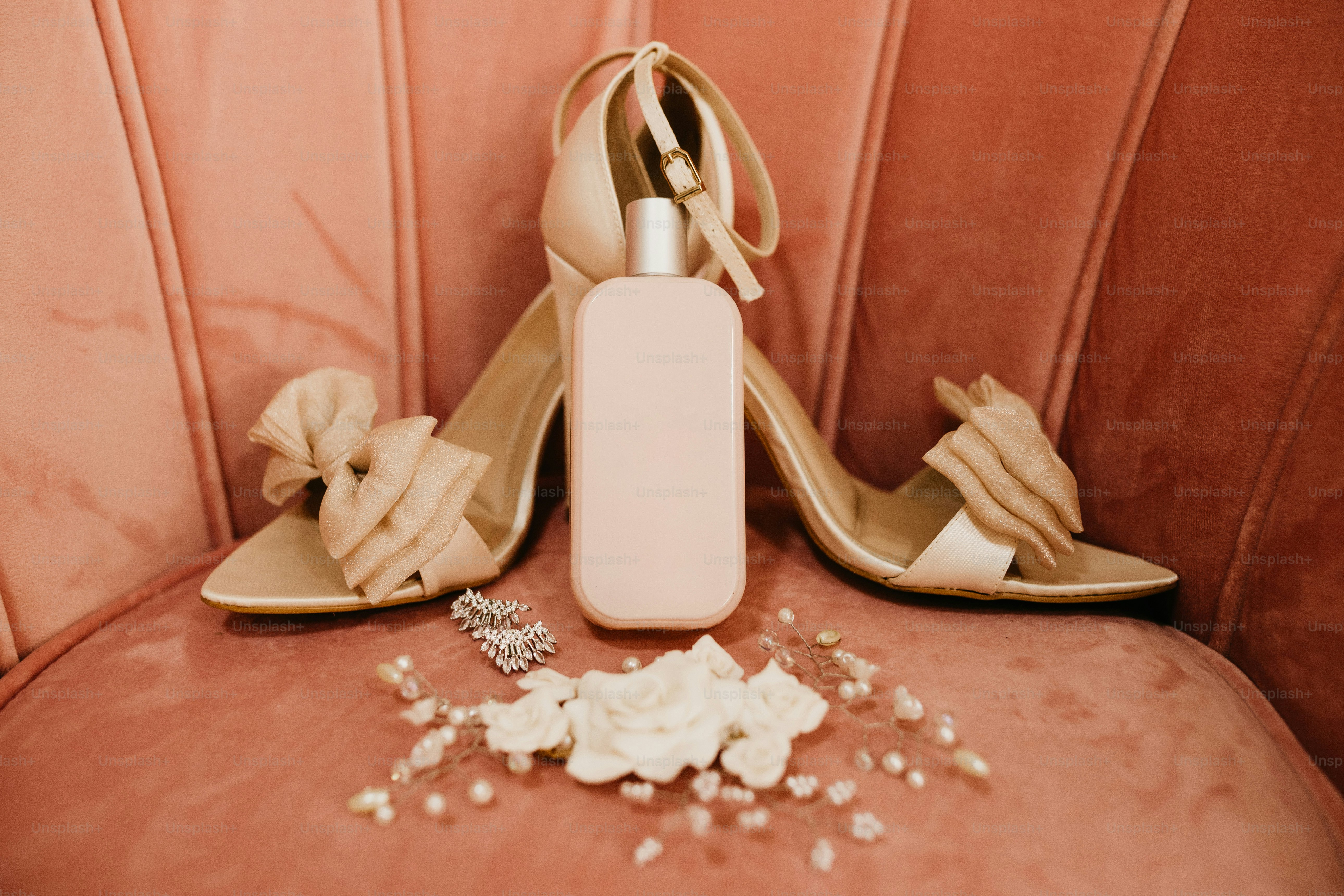 A pair of high heeled shoes next to a bottle of perfume photo ...
