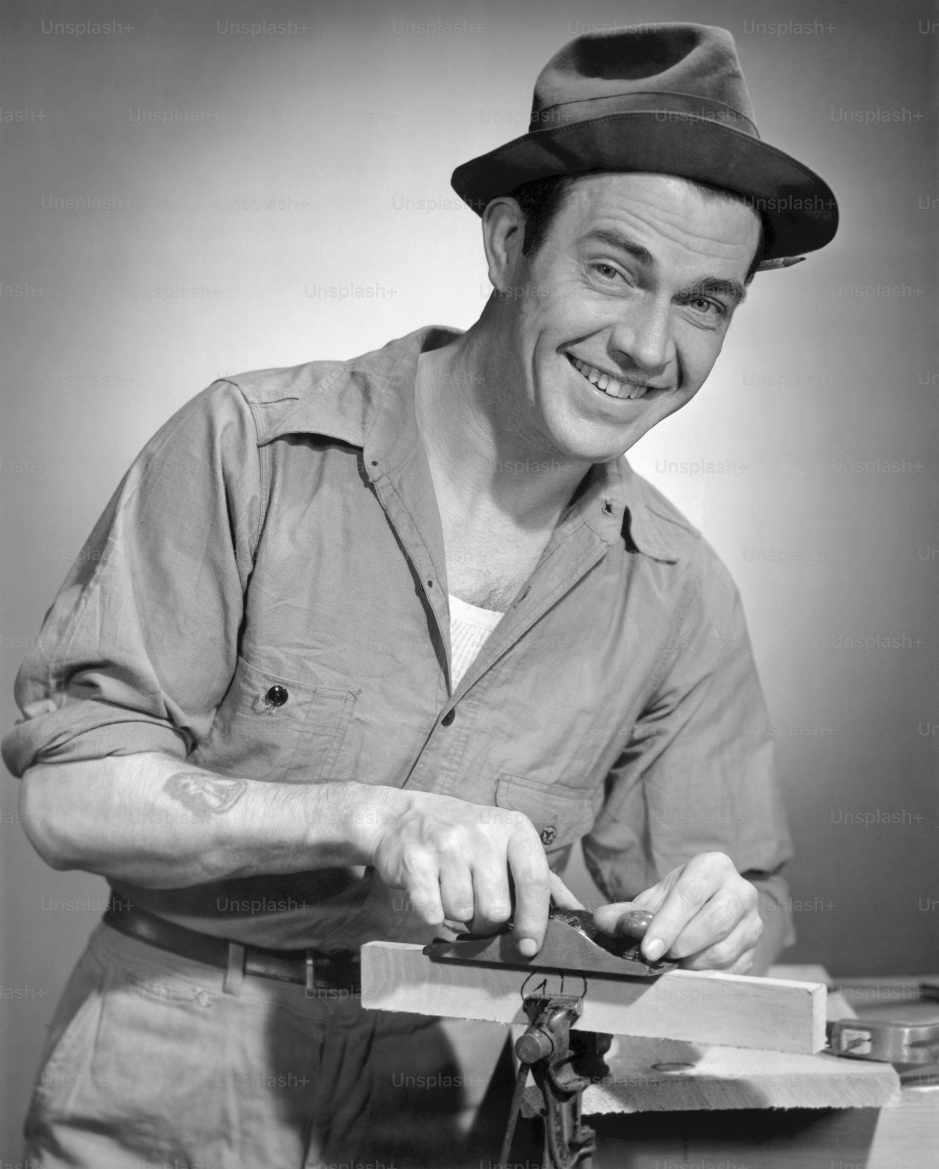 UNITED STATES - CIRCA 1950s: Carpenter planing wood. photo – Adult ...