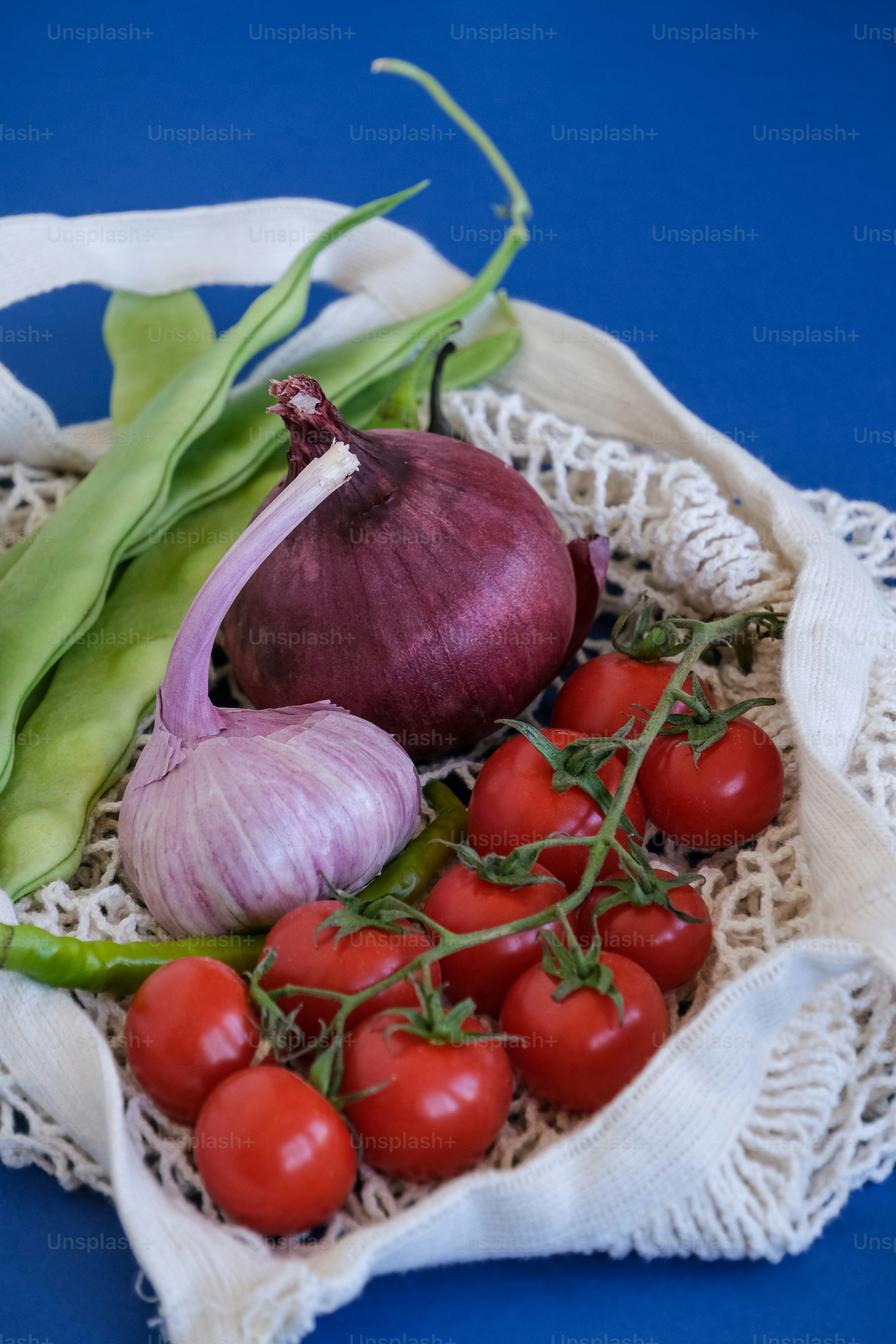 A bunch of vegetables sitting on top of a cloth photo – Vegetables ...