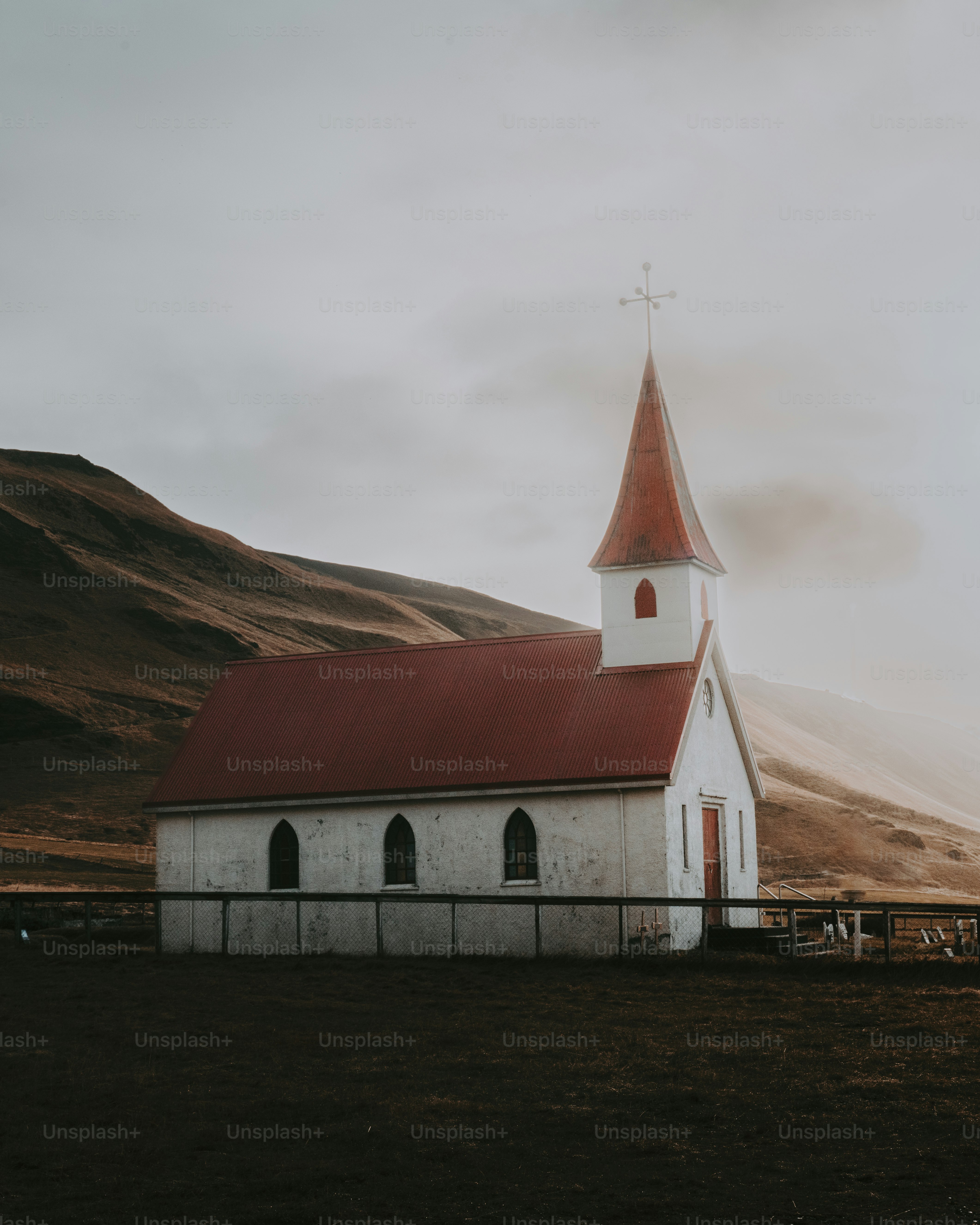A white church with a red roof and a steeple photo – Church Image on ...