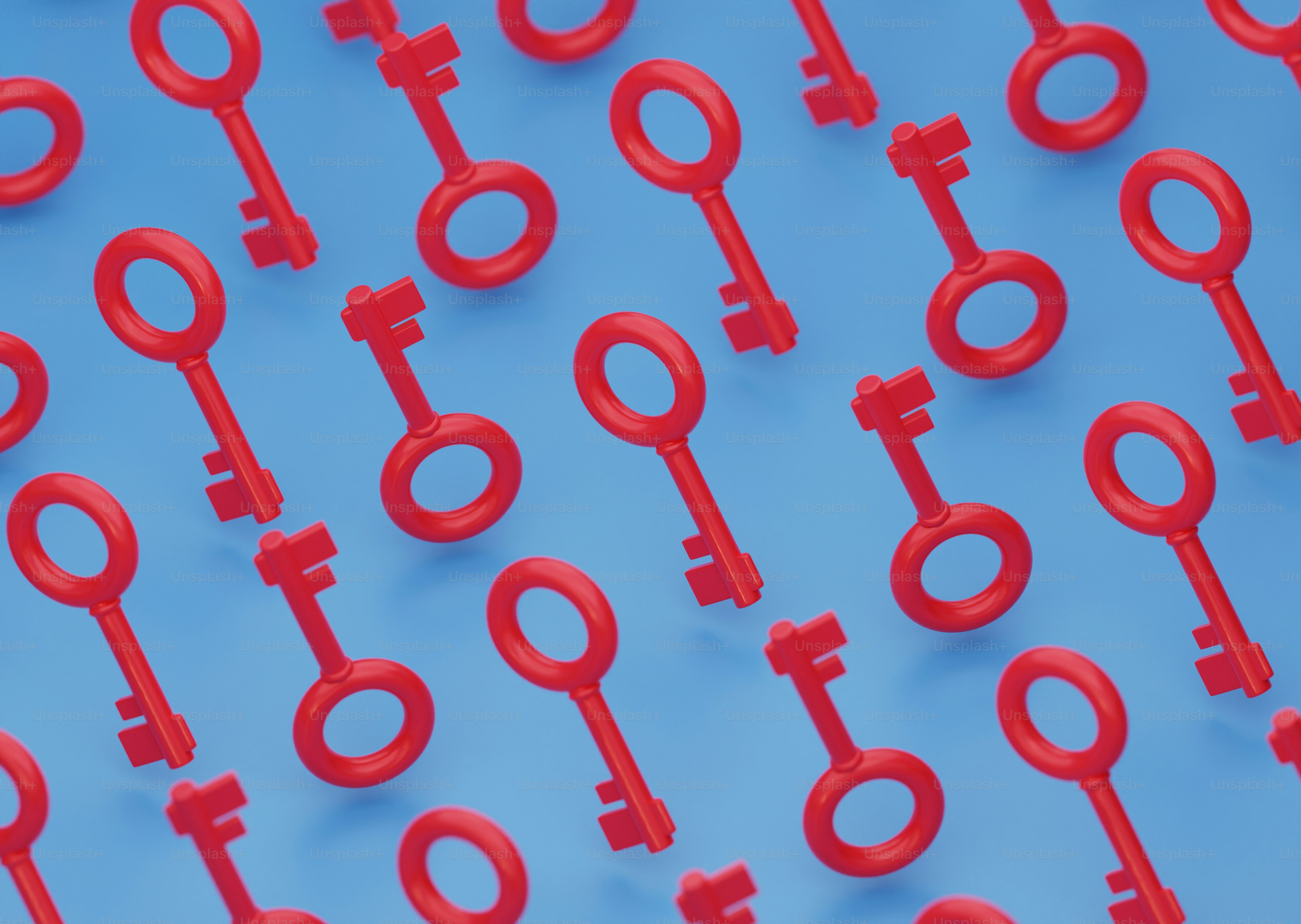 A group of red keys sitting on top of a blue surface photo – Wallpaper ...