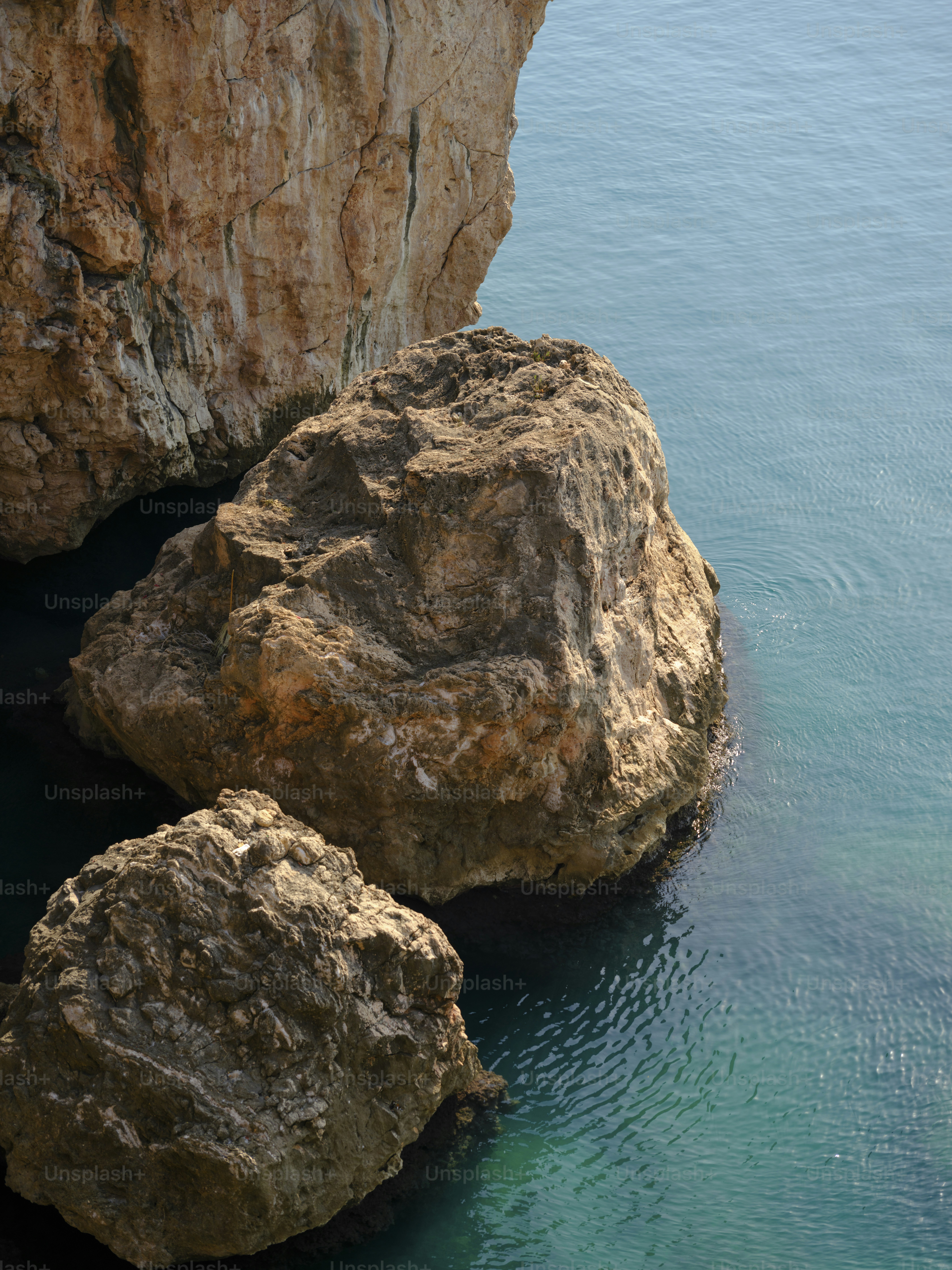Two large rocks sticking out of the water photo – Rocky Image on Unsplash