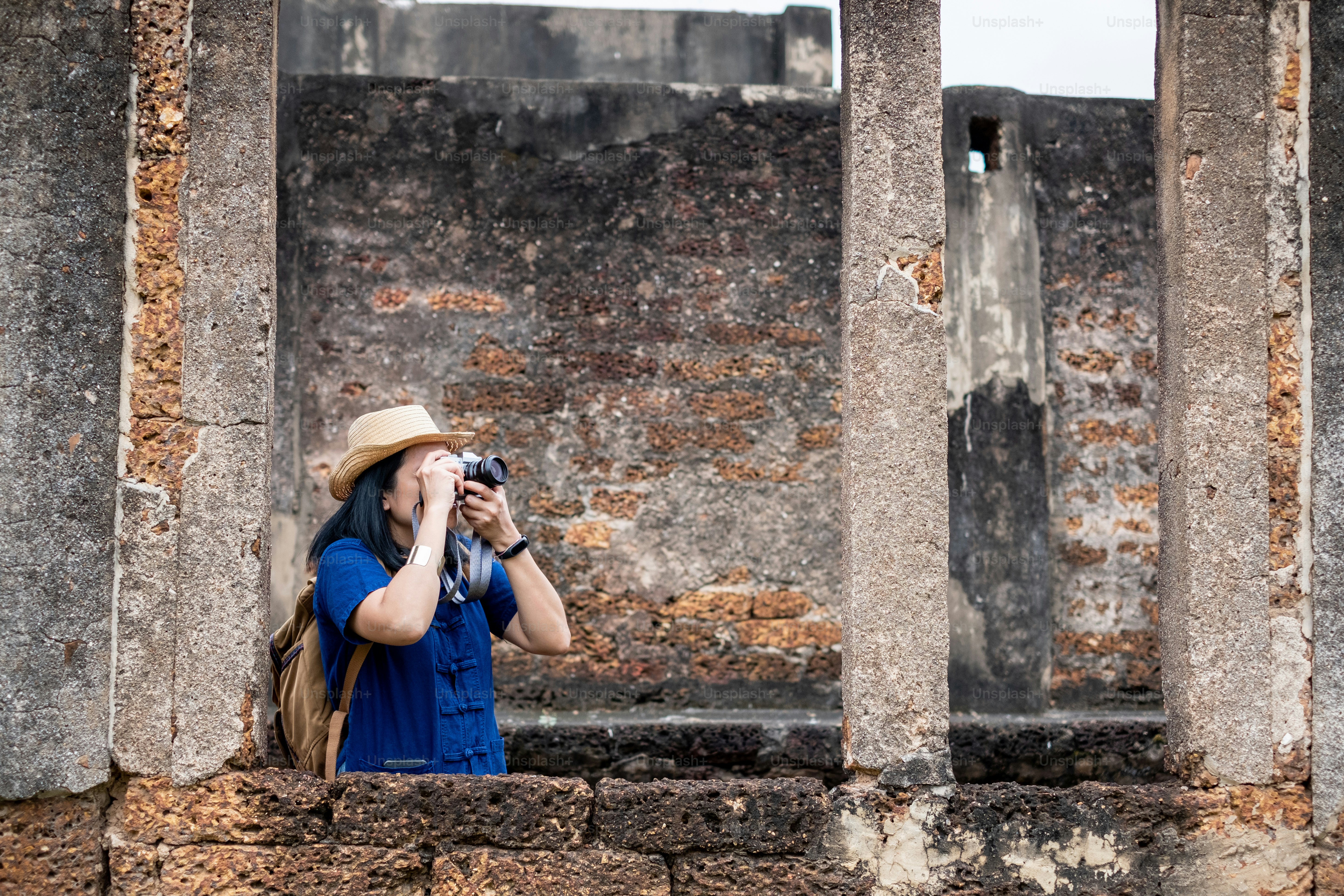 Asian tourist woman use mobile take a photo of ancient of pagoda temple ...