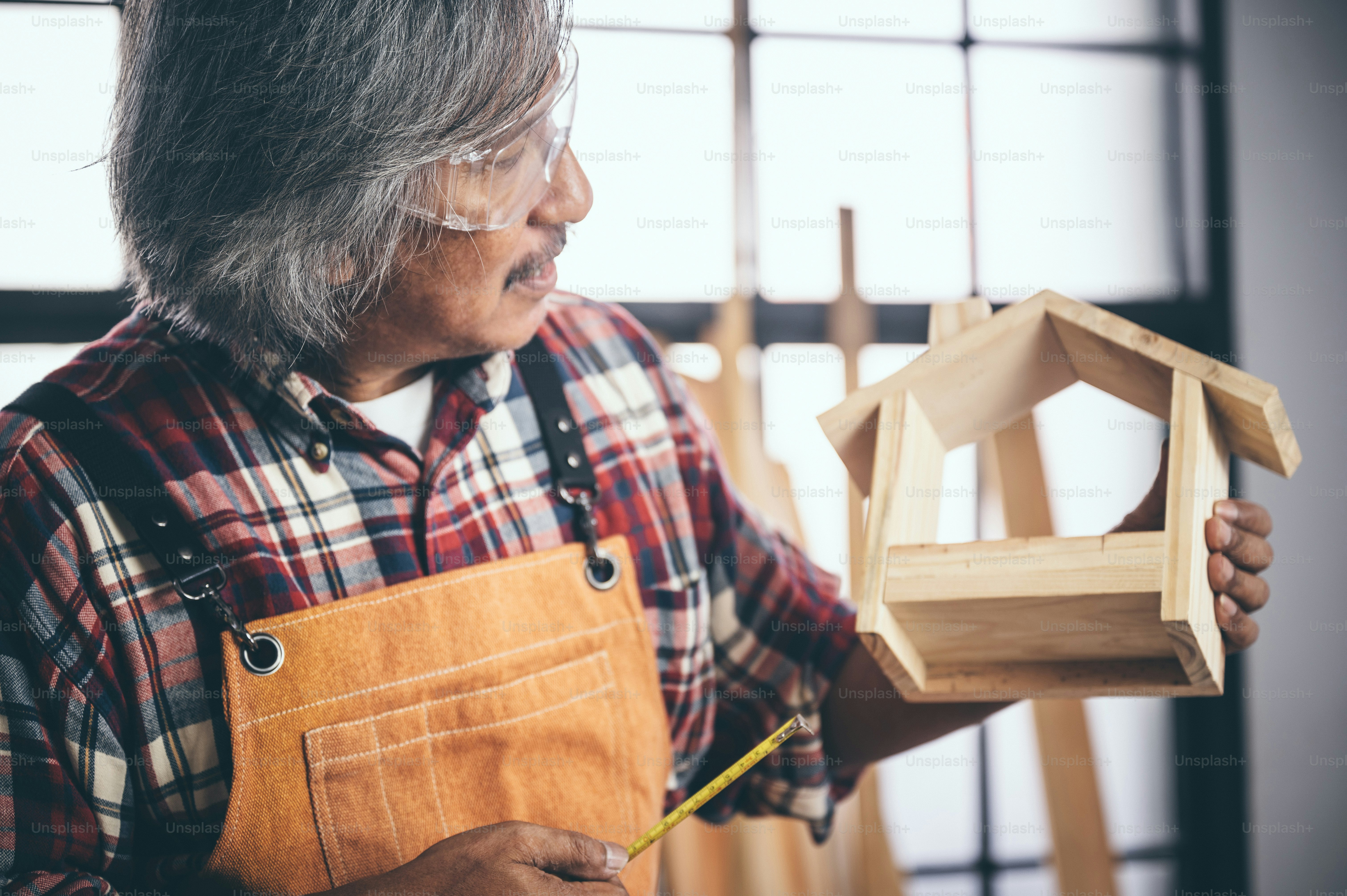 A carpenter is designing and working on hand-made wood. photo ...