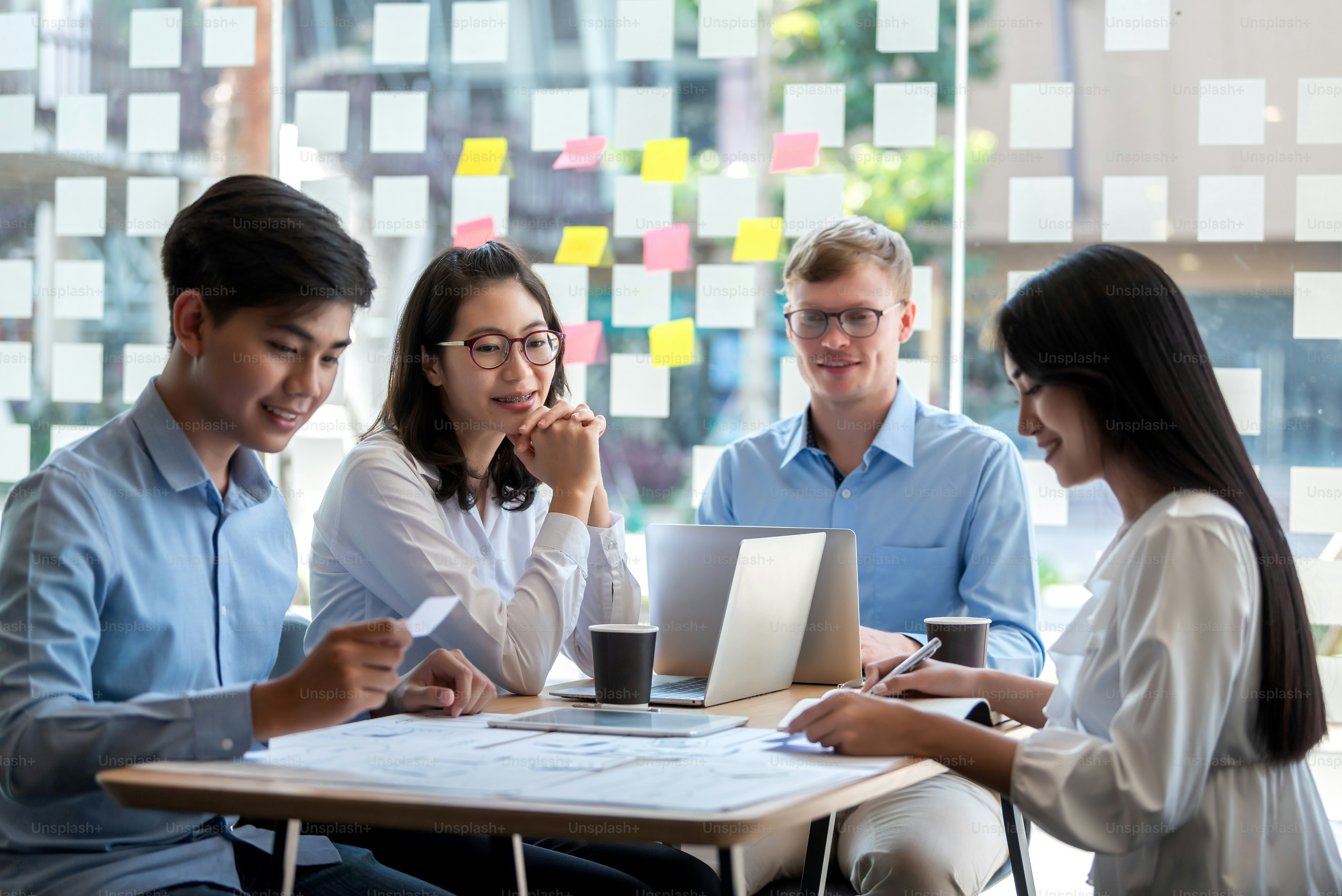 Teamwork of young asian business people meeting to discuss and plan ...