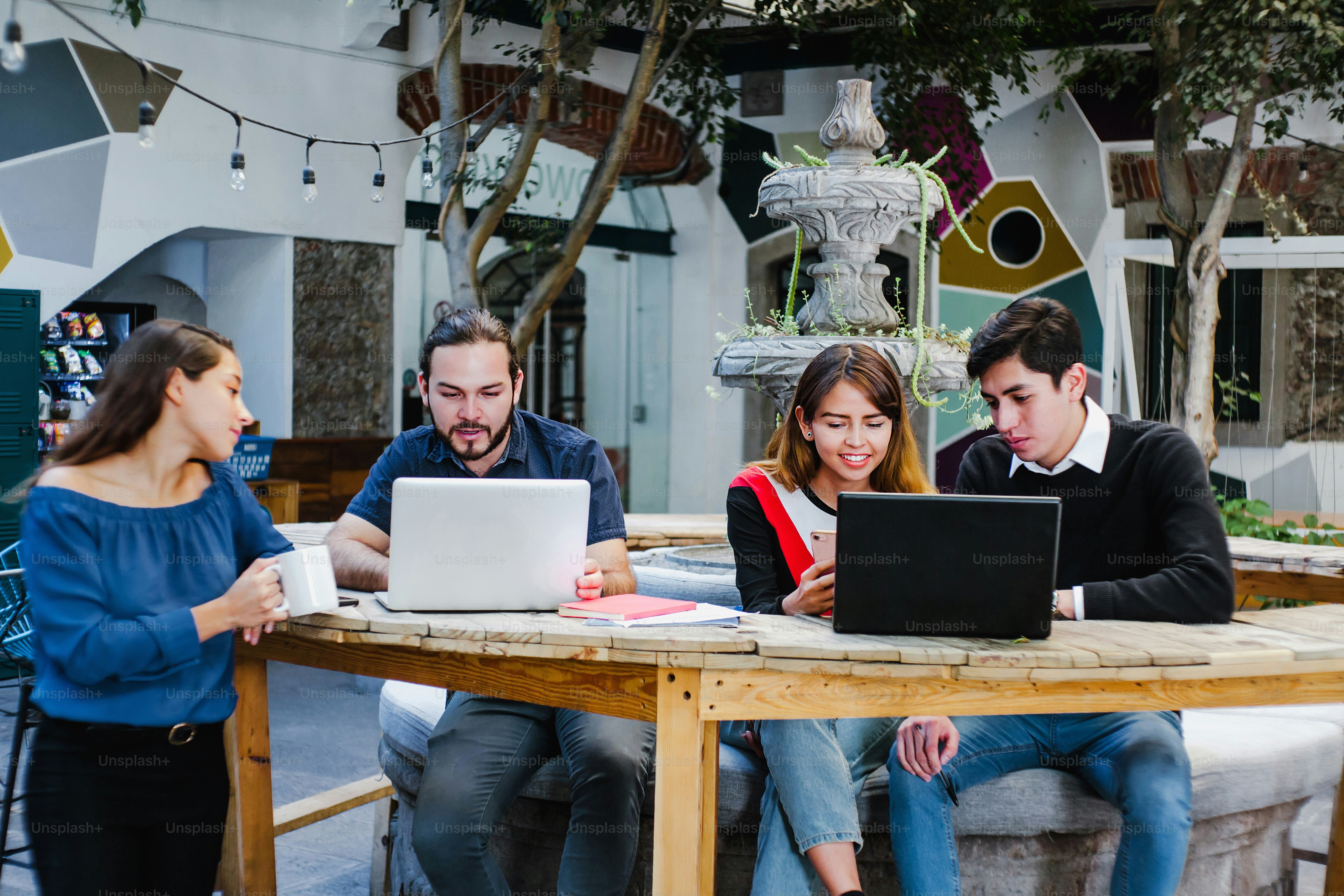 Group of young hispanic college students studying together at ...