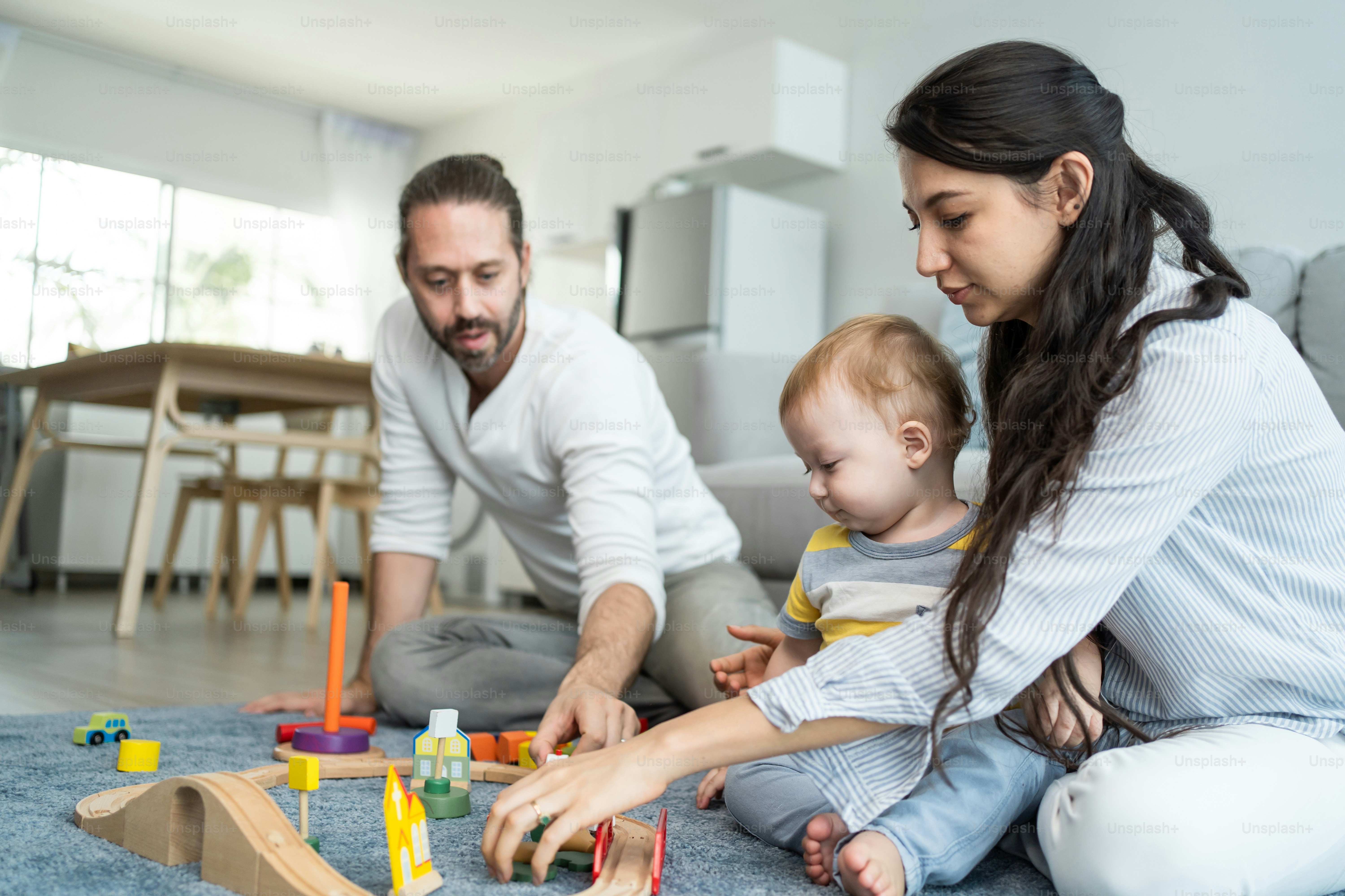Caucasian happy loving parent play with baby toddler in living room ...