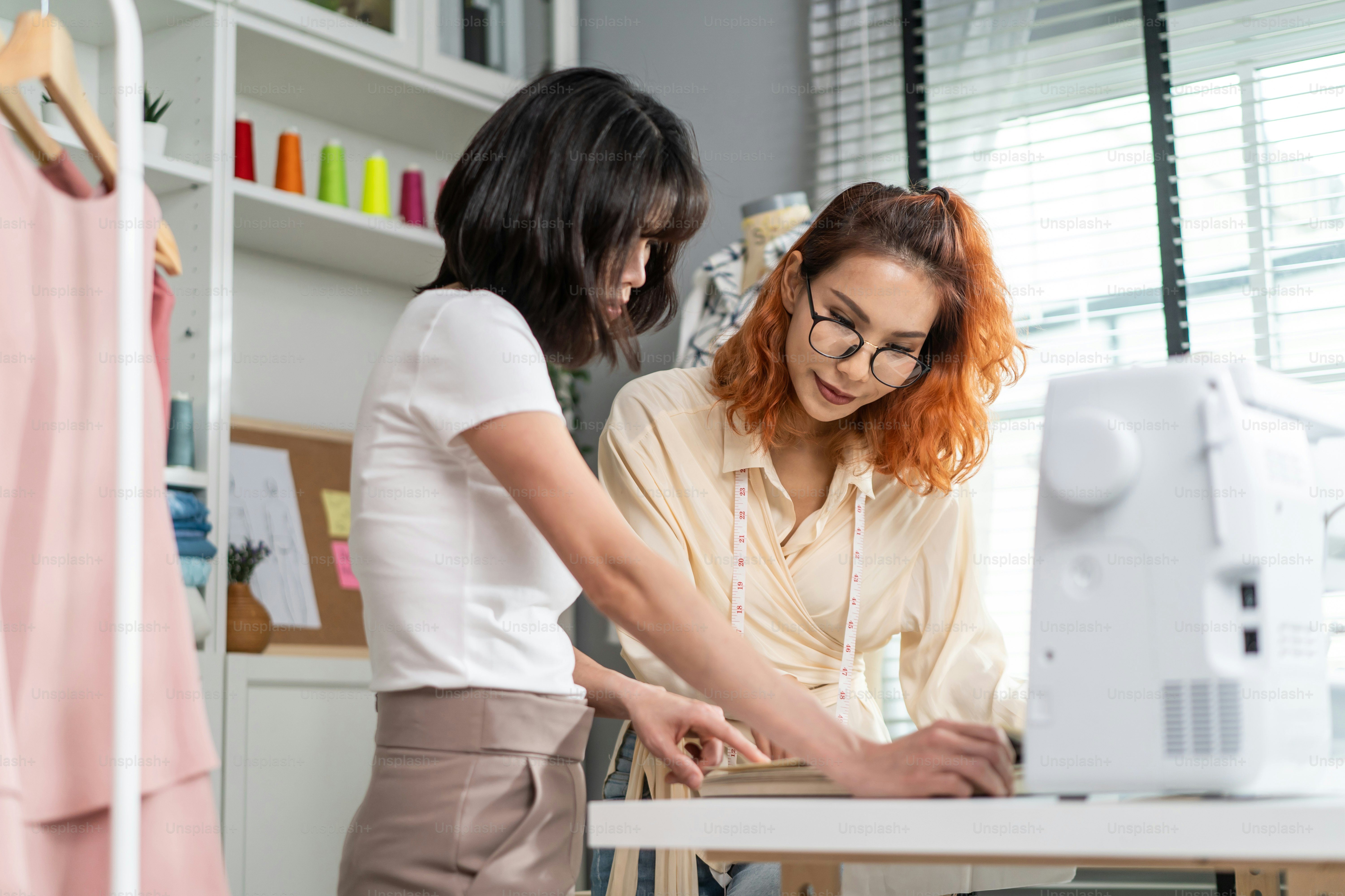 Asian tailor women working to design new clothes in tailoring atelier ...