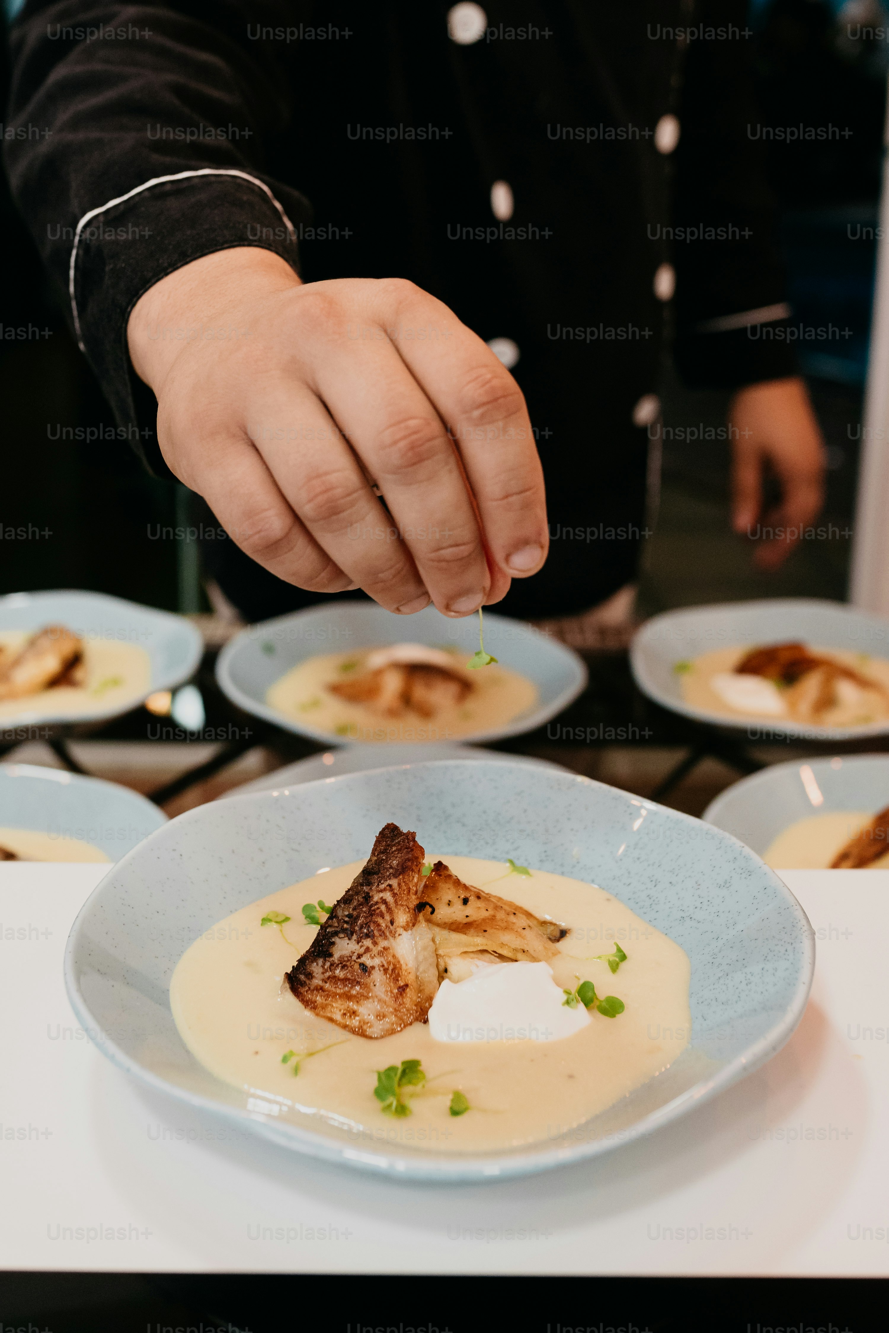 A person reaching for a piece of food on a plate photo – Sprinkling ...