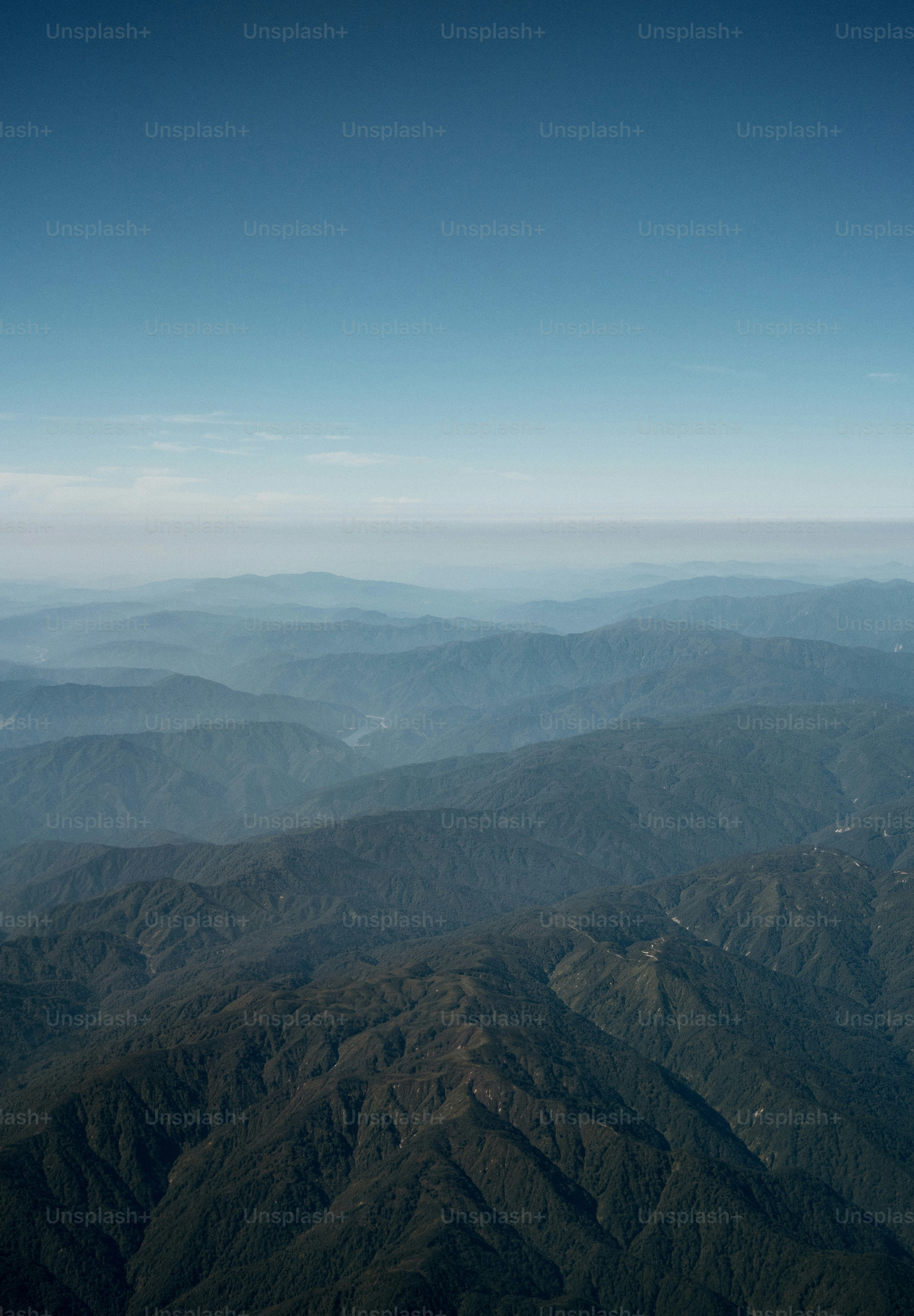 A view of a mountain range from an airplane photo – Nature Image on ...